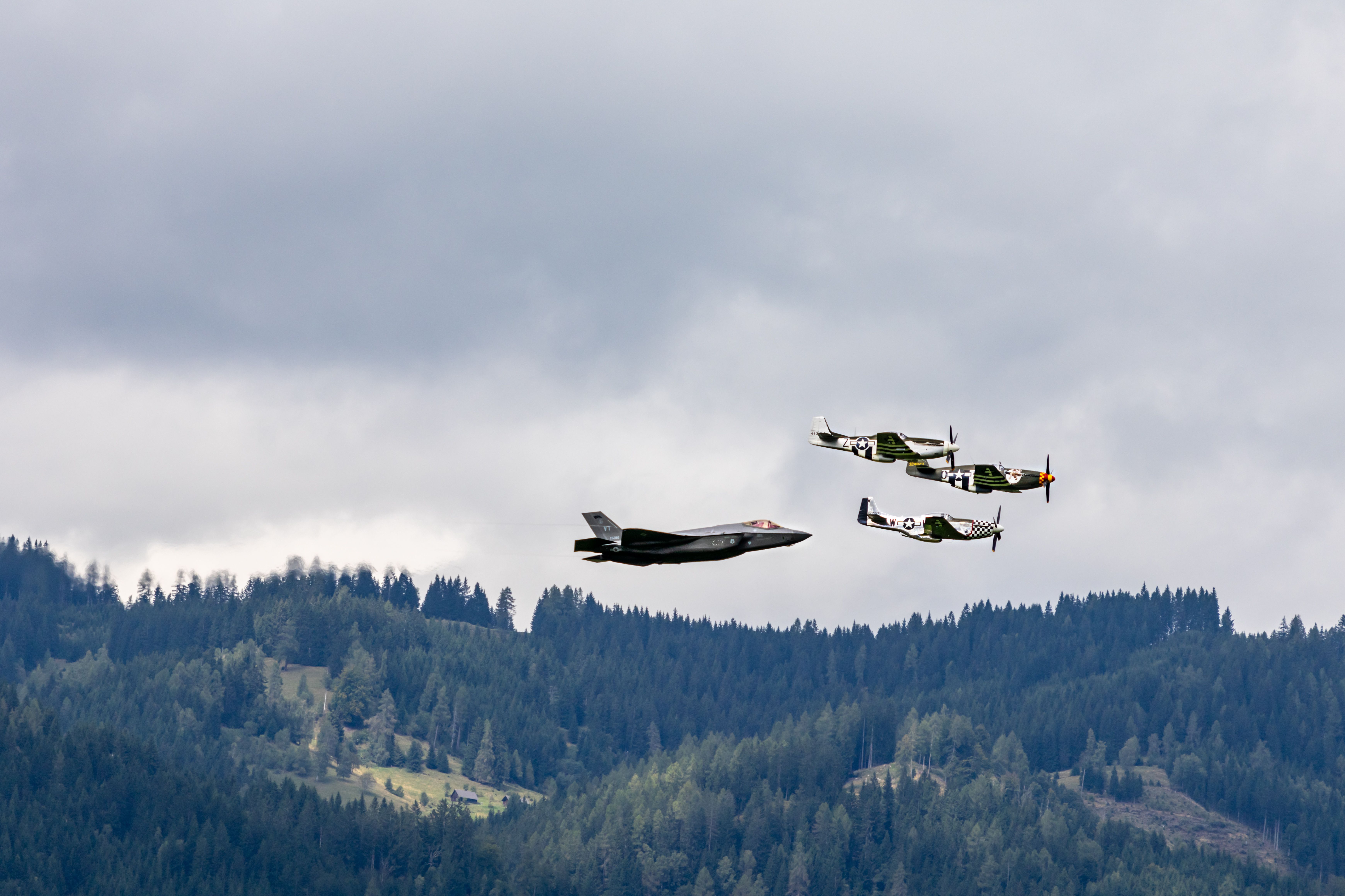 World War II and Modern Fighters Flying over Forest · Free Stock Photo