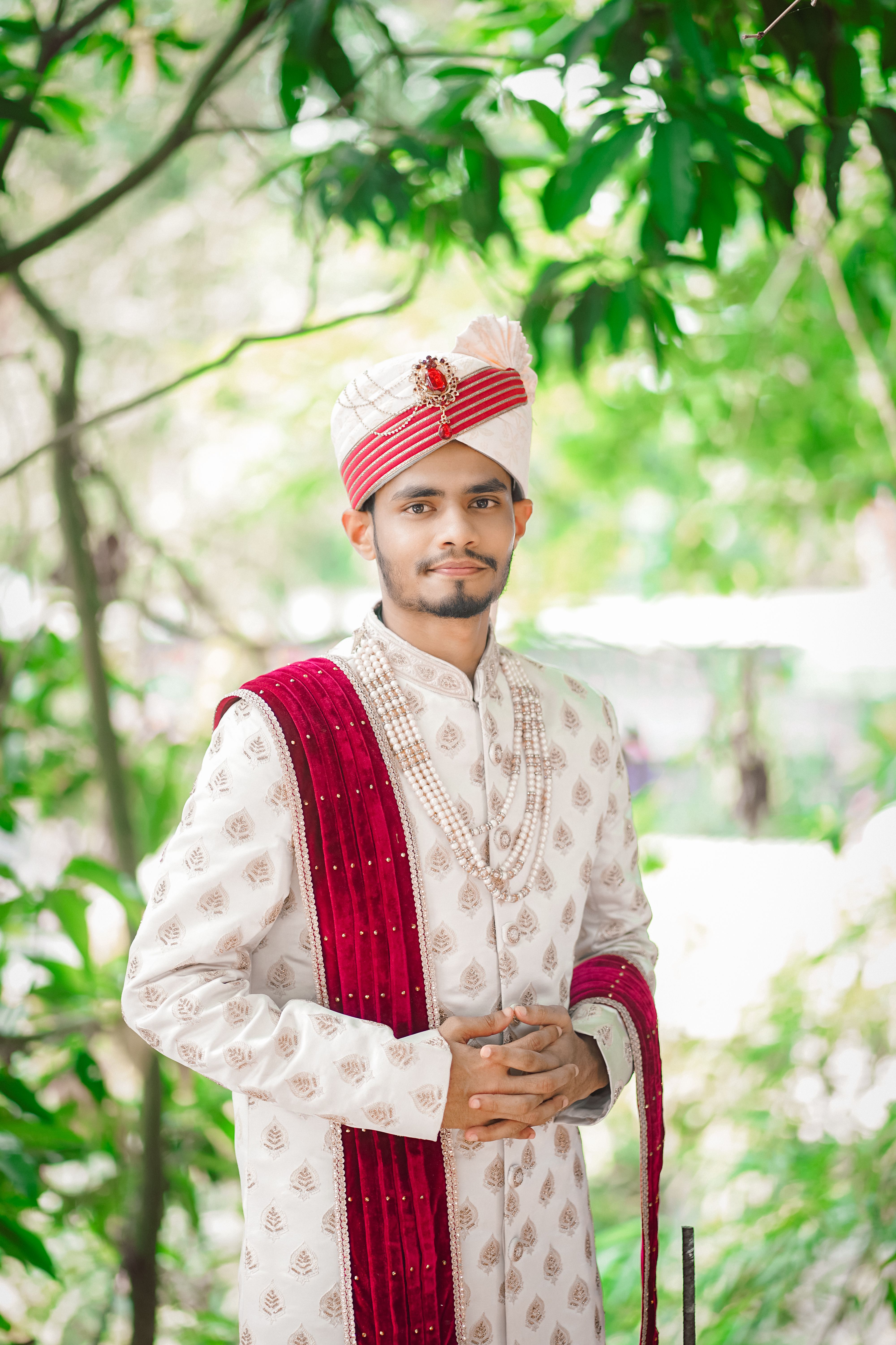 Elegant Groom in a Traditional Bangladeshi Costume Standing Under a ...