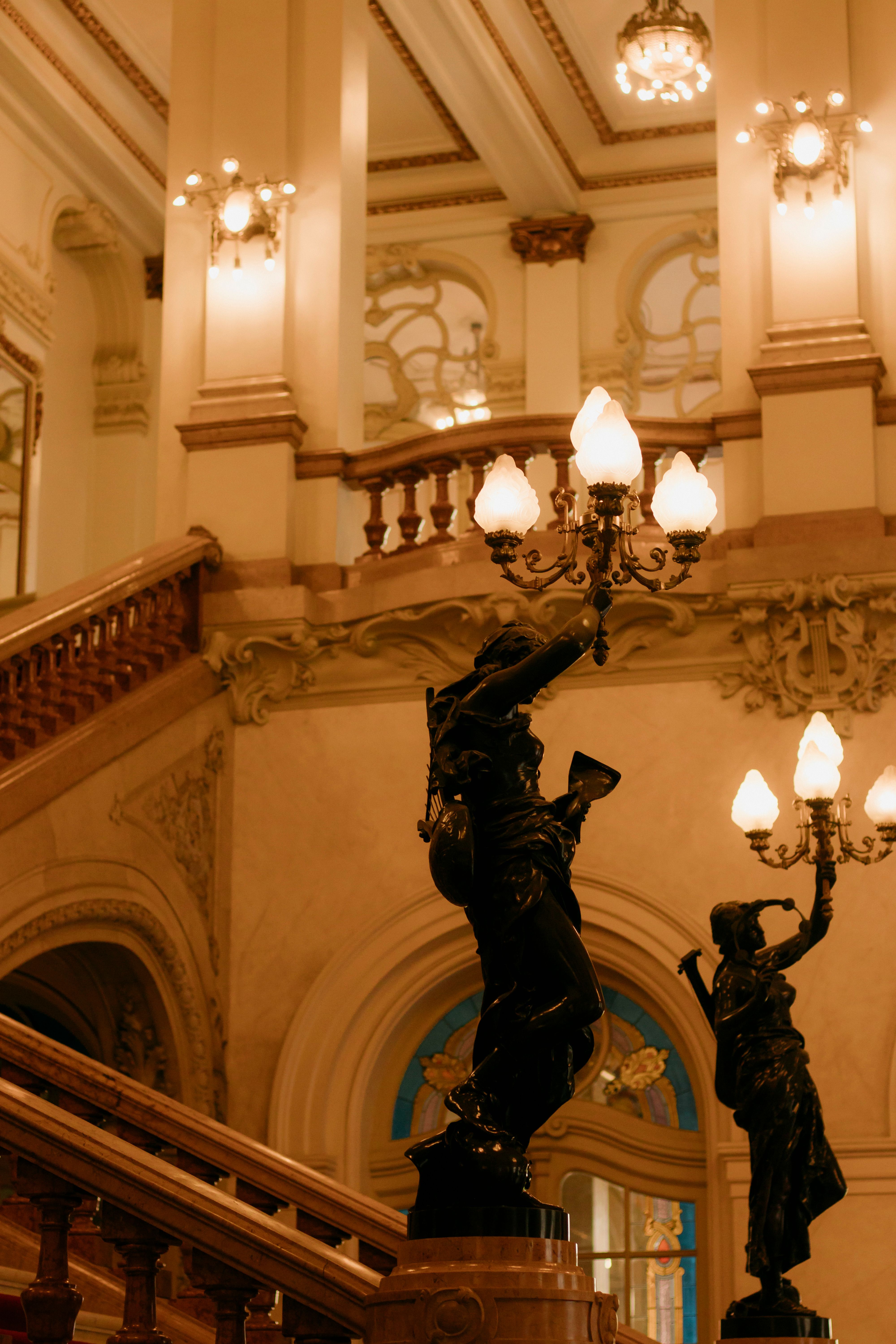 Statues on the stairs of a building with lights · Free Stock Photo