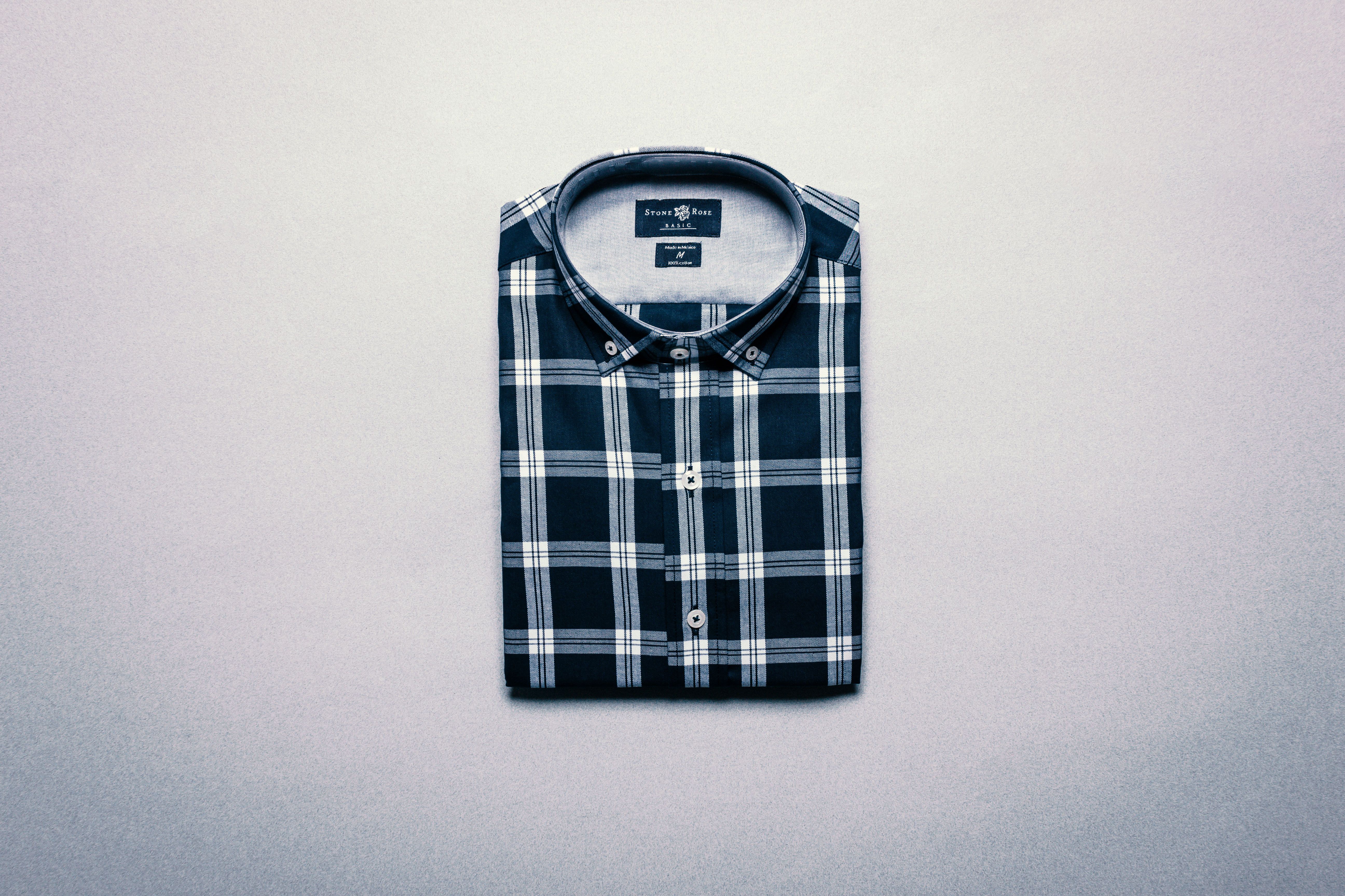 Folded Plaid Shirt on Gray Background Top View · Free Stock Photo