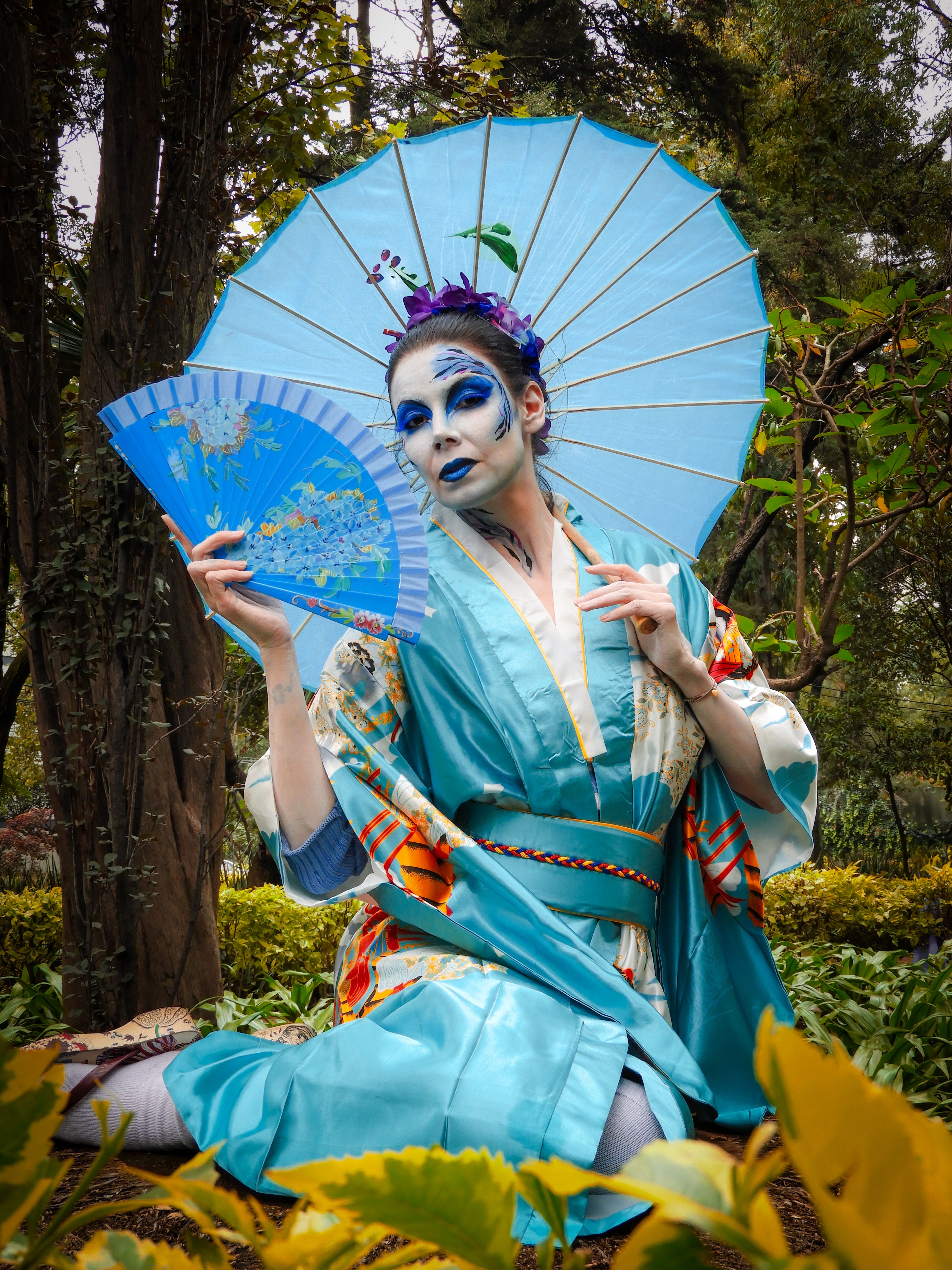 Geisha in Traditional Clothing and with Umbrella and Fan · Free Stock Photo