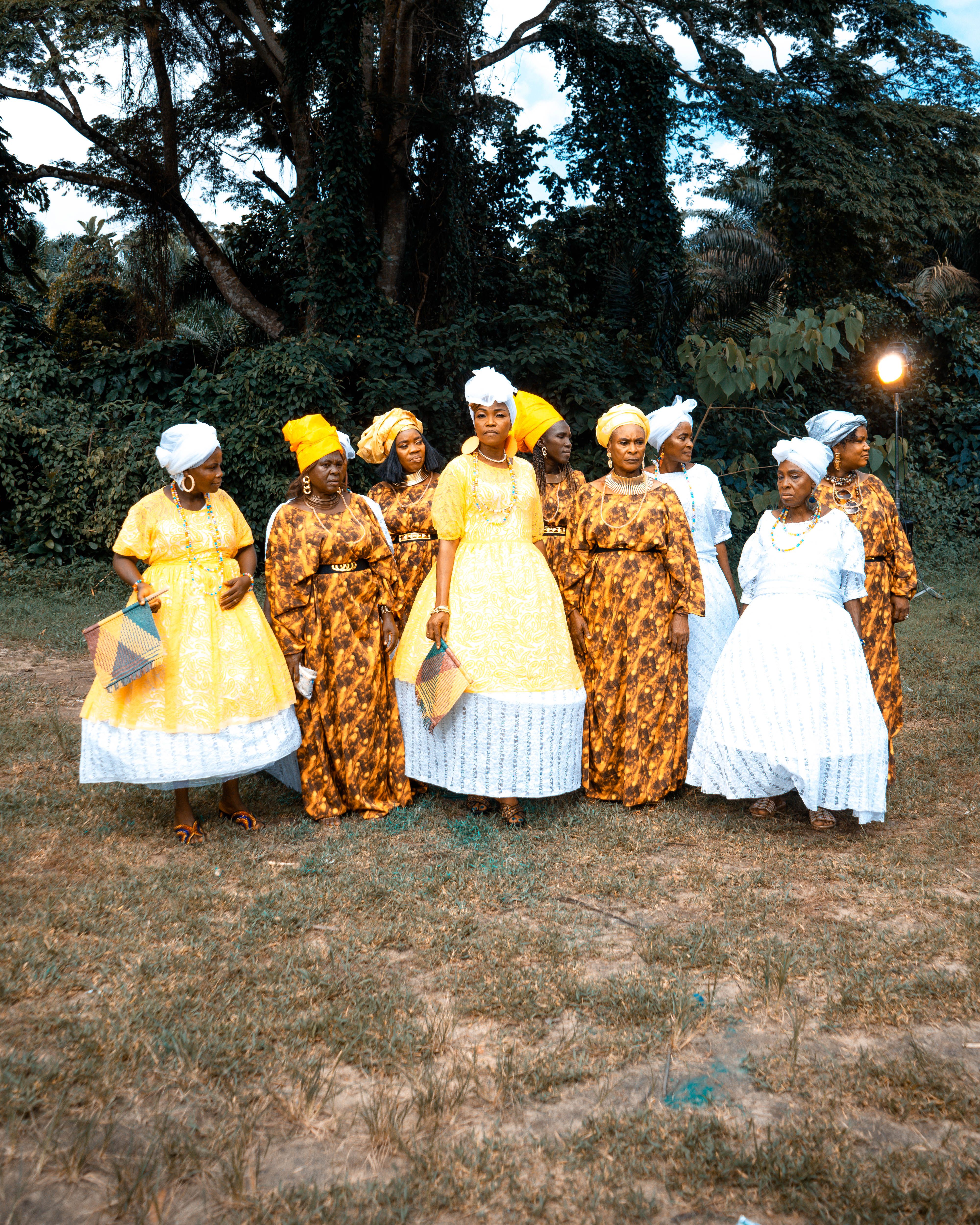 A Group of Women Wearing Turbans and Traditional Dresses Standing ...