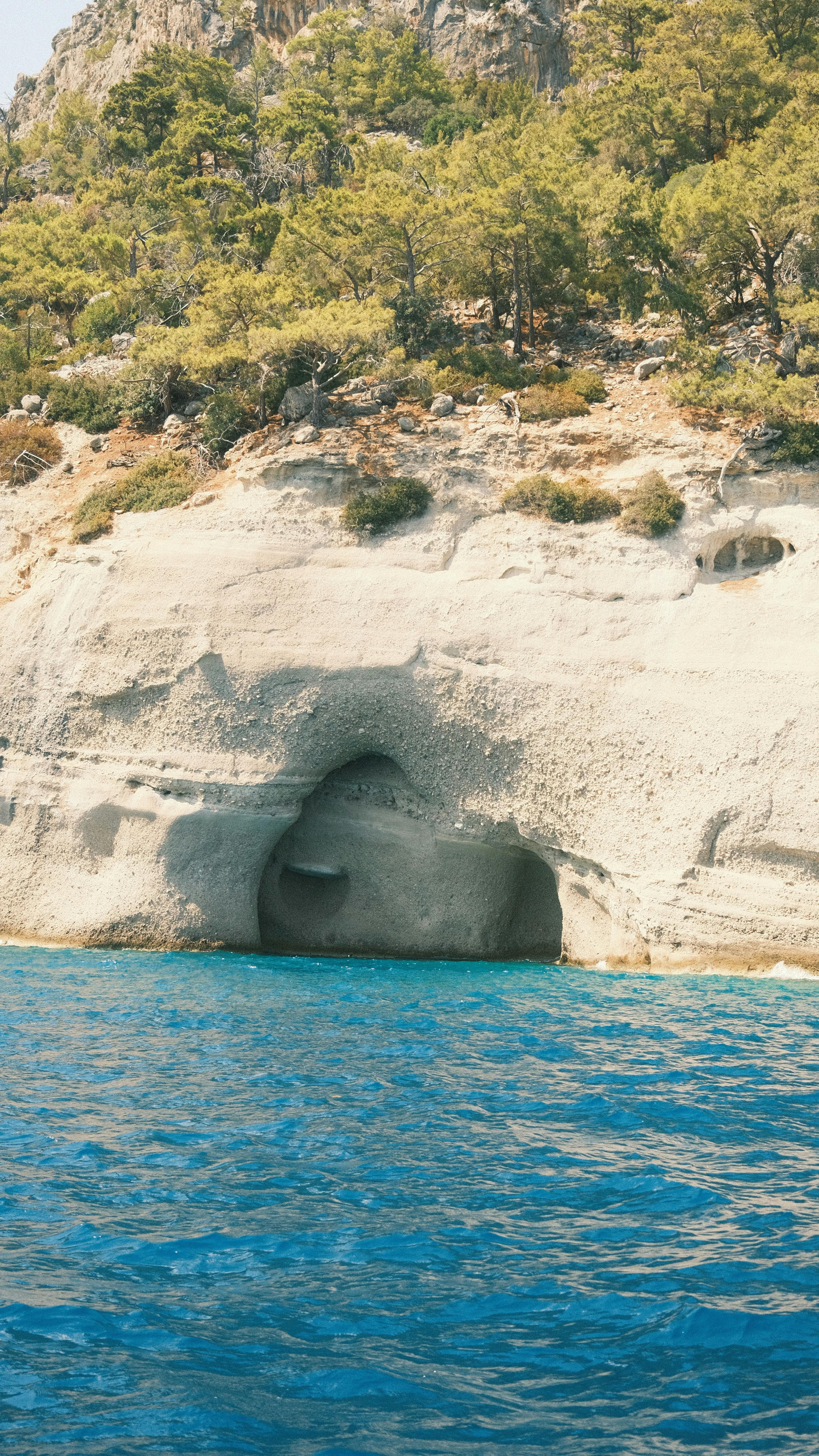 View of a Cave in a Cliff on the Seashore · Free Stock Photo