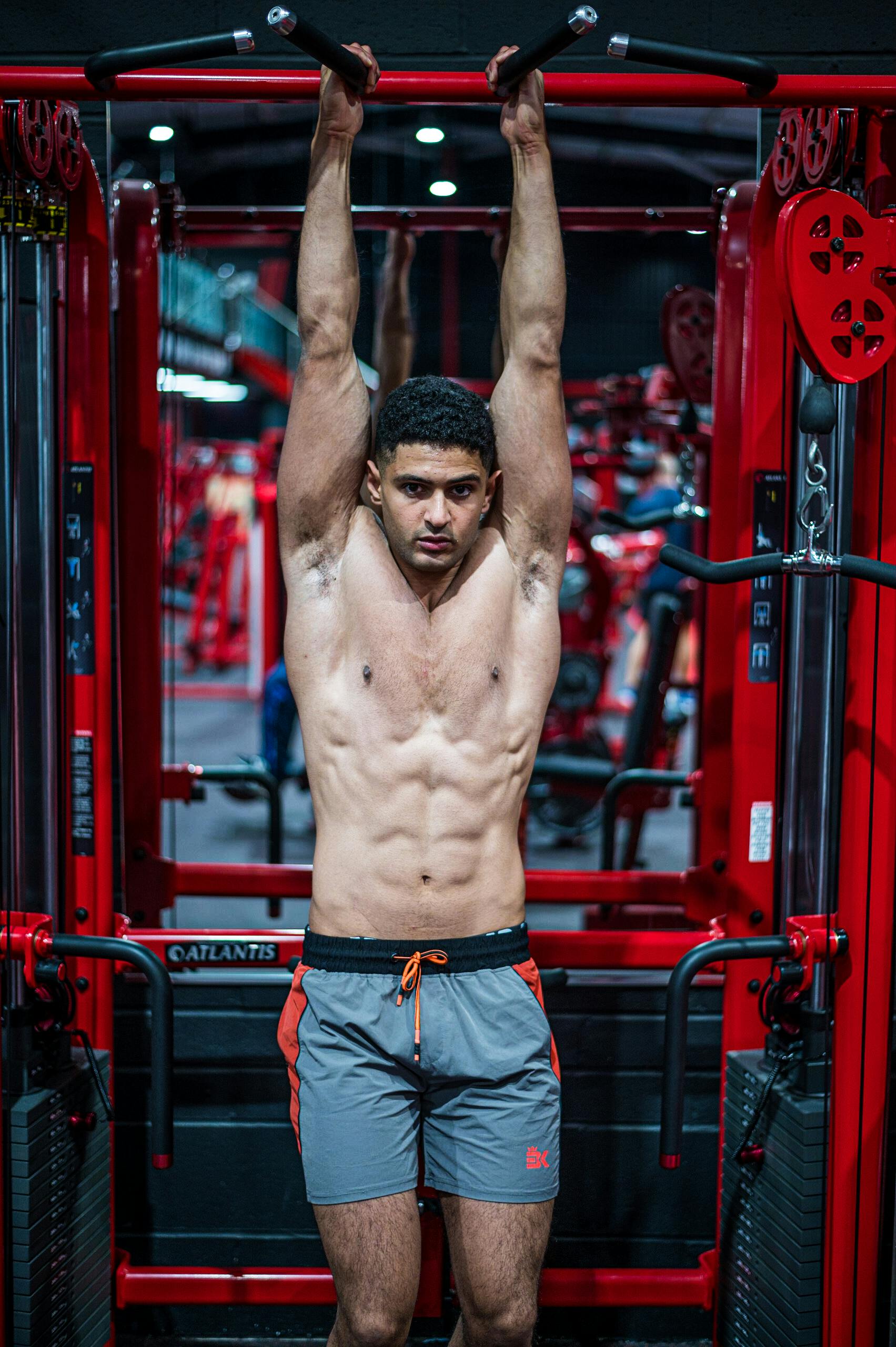 A man doing pull ups in a gym · Free Stock Photo