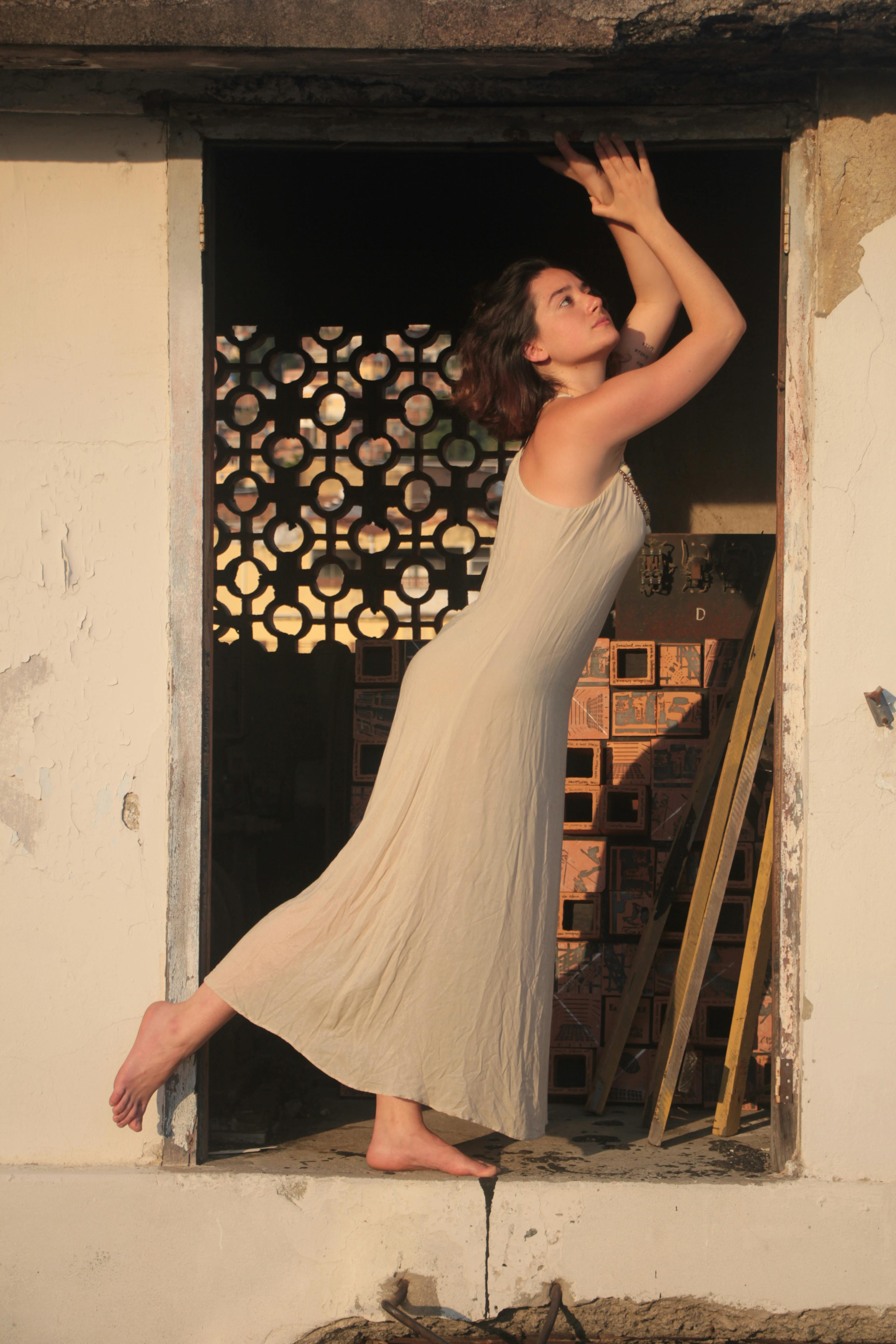 Photo Of Woman Standing In The Doorway · Free Stock Photo