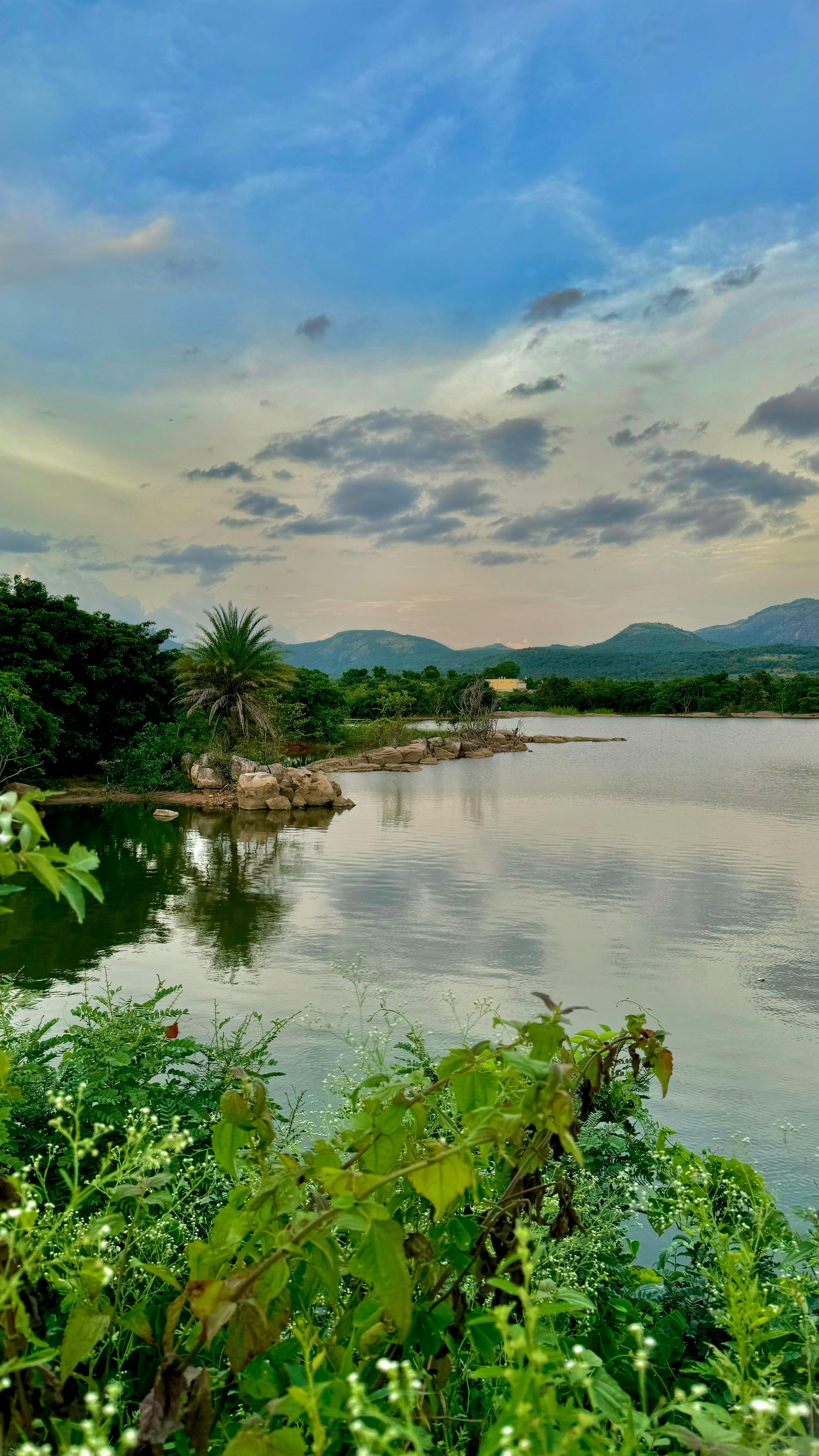 A lake with a view of mountains and clouds · Free Stock Photo
