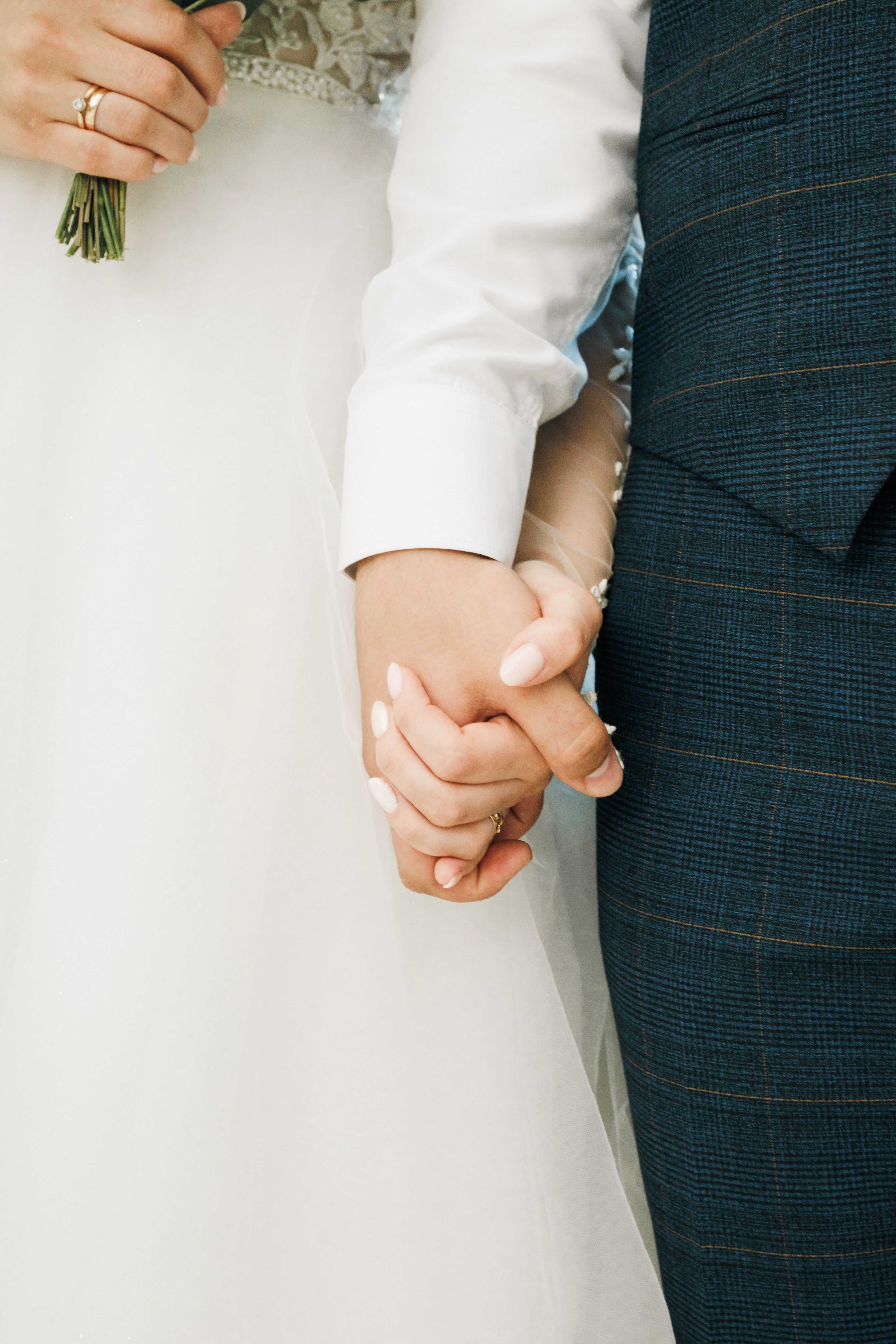 Close-Up of Couple Holding Hands at Wedding · Free Stock Photo