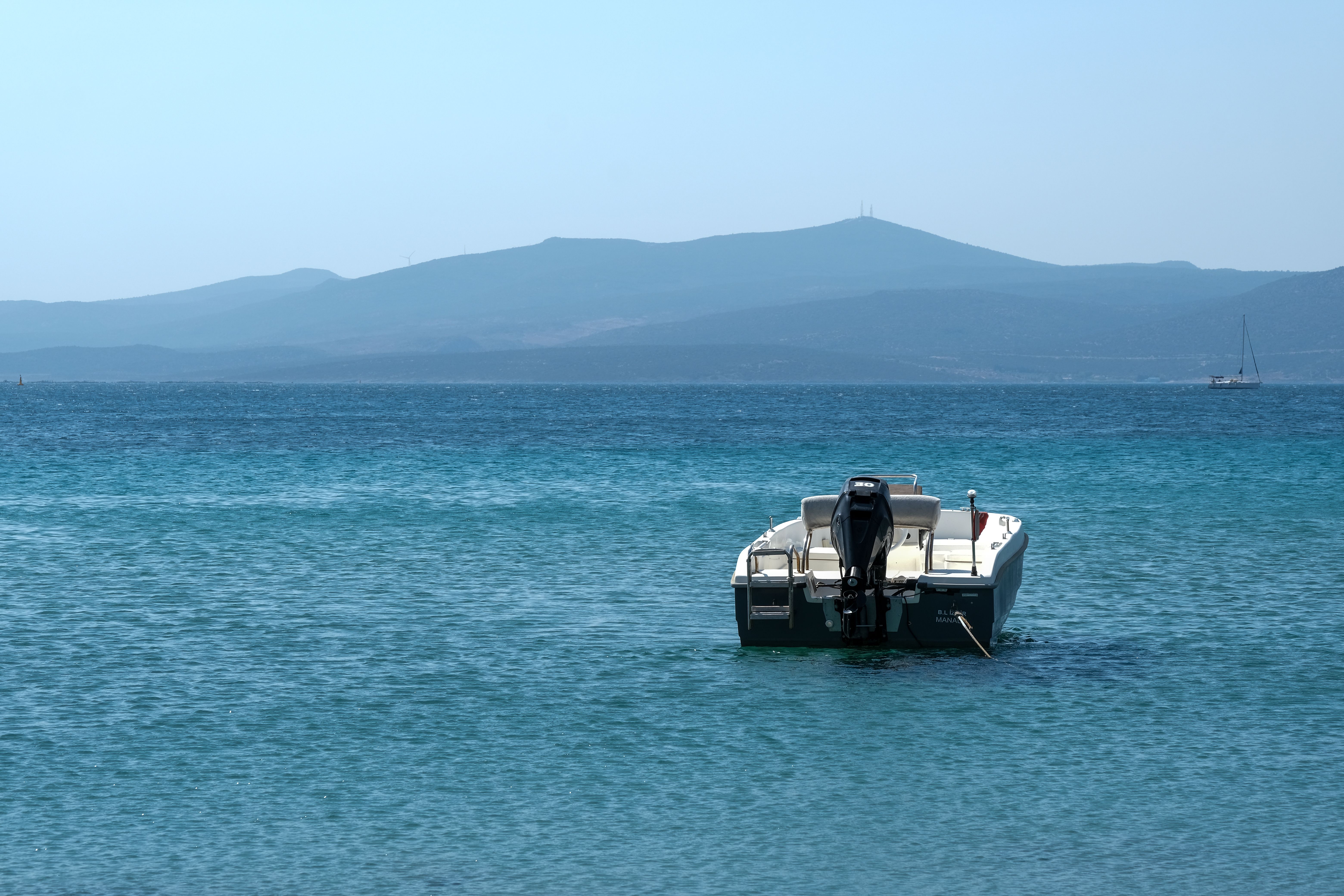 Small Boat Anchored in Tranquil Blue Waters on a Sunny Day · Free Stock ...