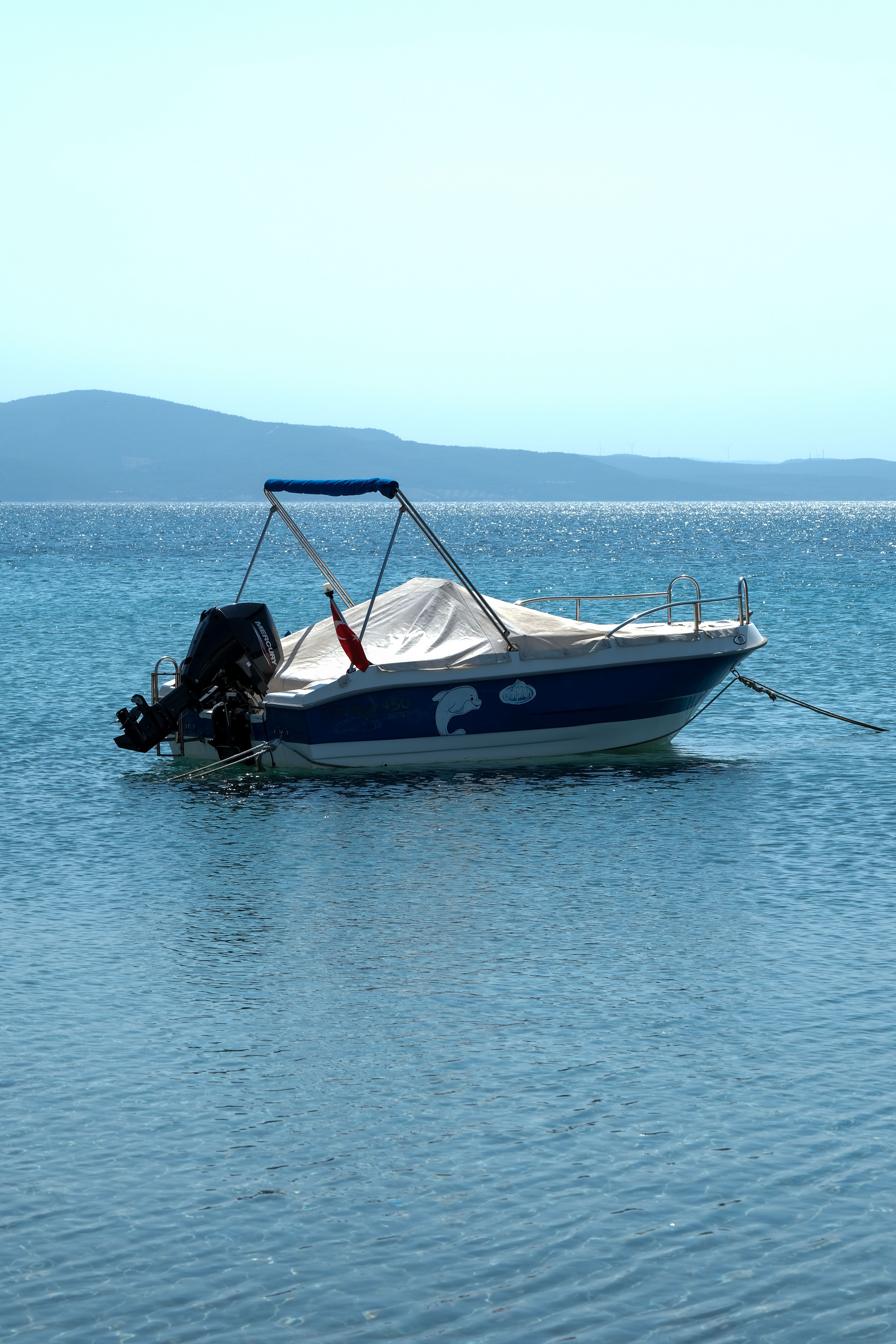 Small Boat Anchored in Tranquil Blue Waters on a Sunny Day · Free Stock ...
