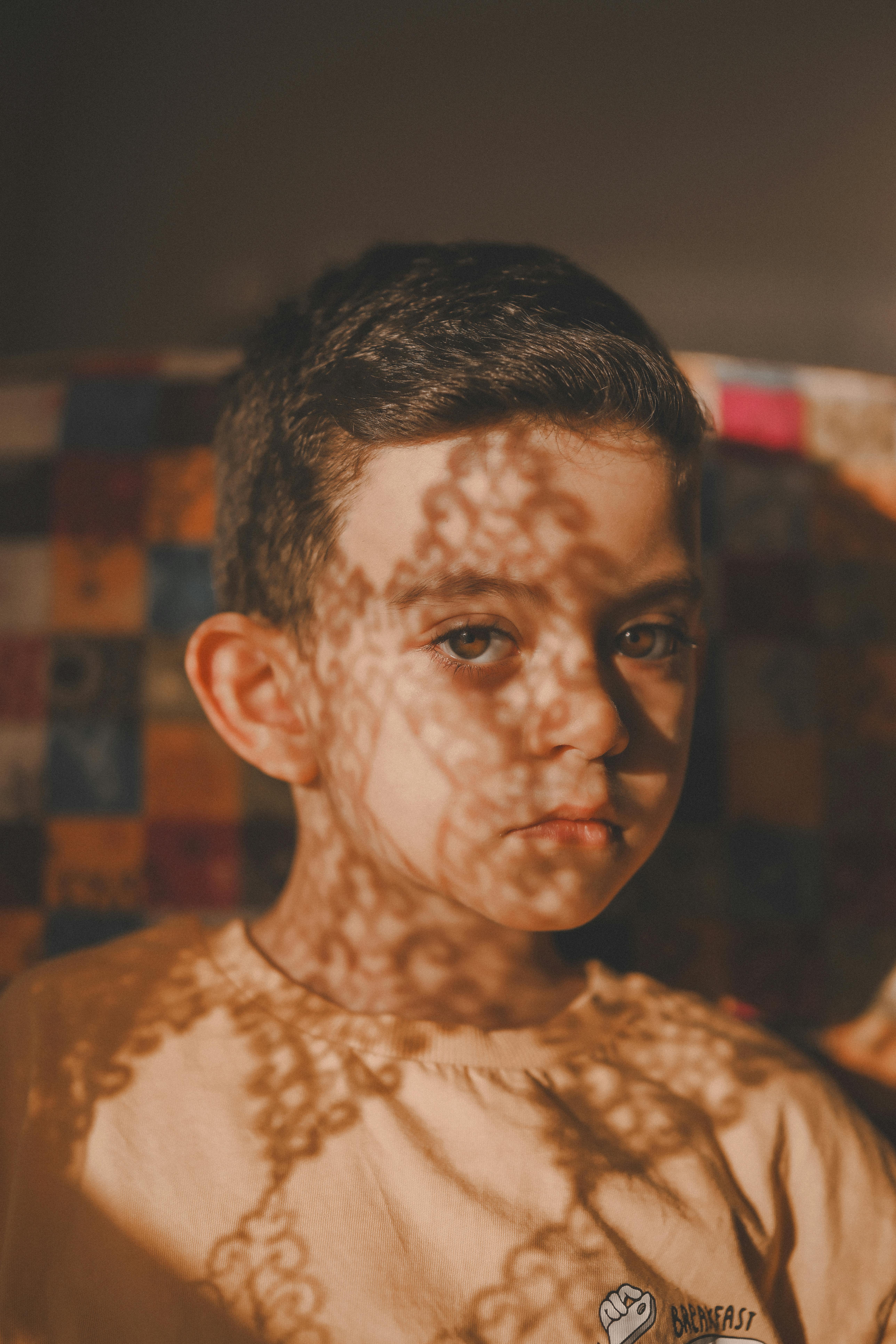 Dramatic Portrait of a Young Boy in Warm Light · Free Stock Photo