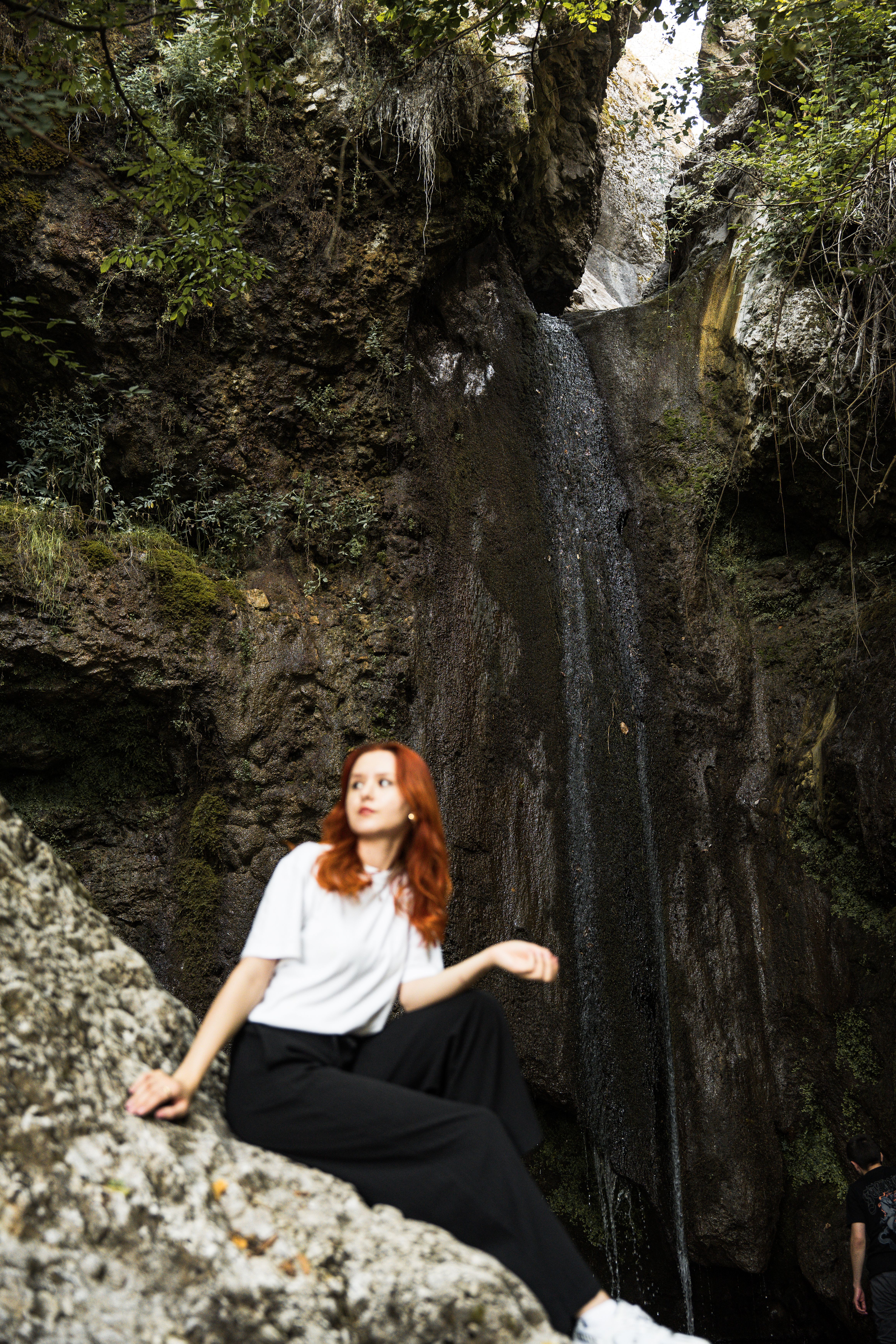 Woman Sitting near Waterfall · Free Stock Photo
