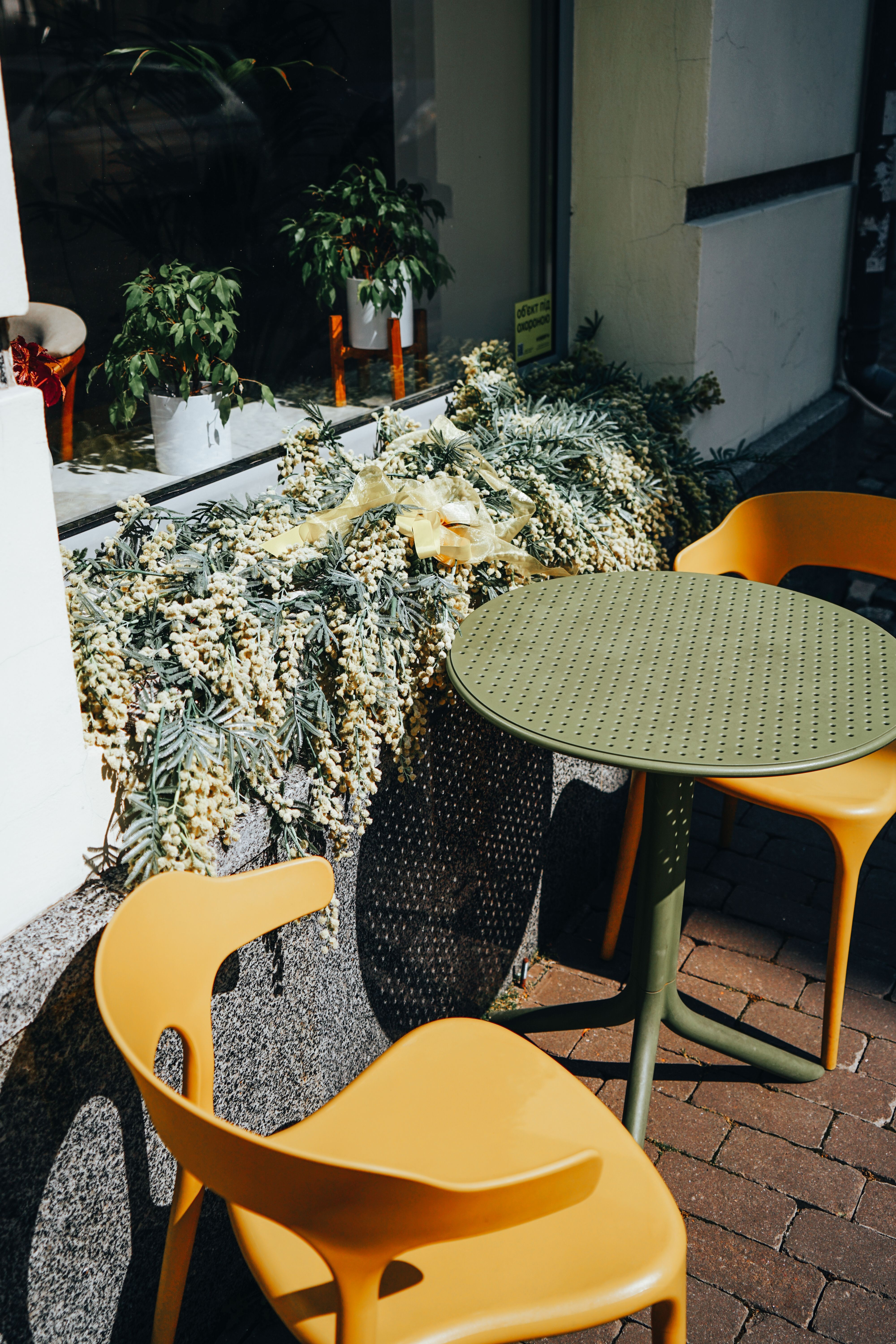 Cozy Outdoor Café Setup with Yellow Chairs · Free Stock Photo