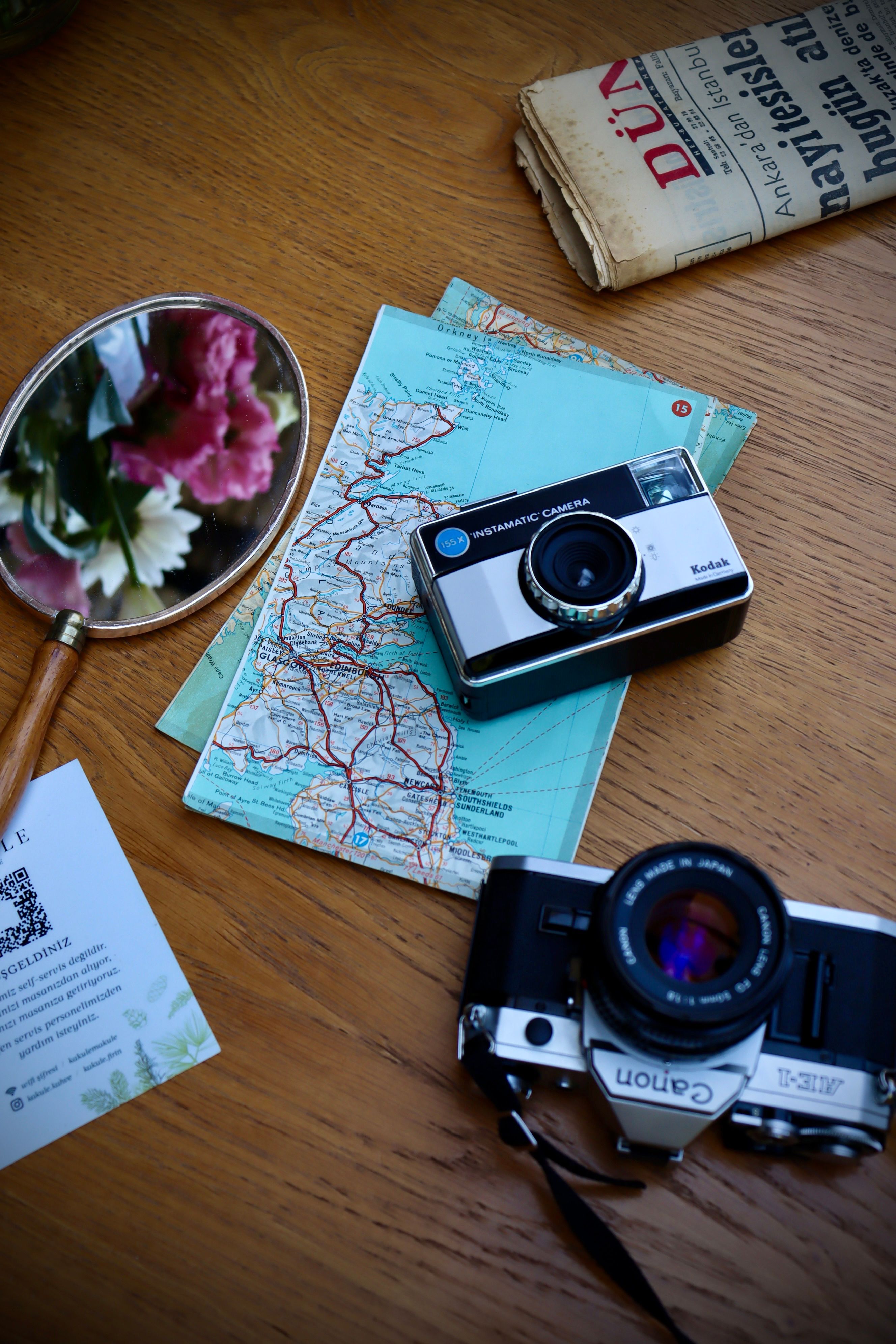 A camera, a map and a magnifying glass · Free Stock Photo