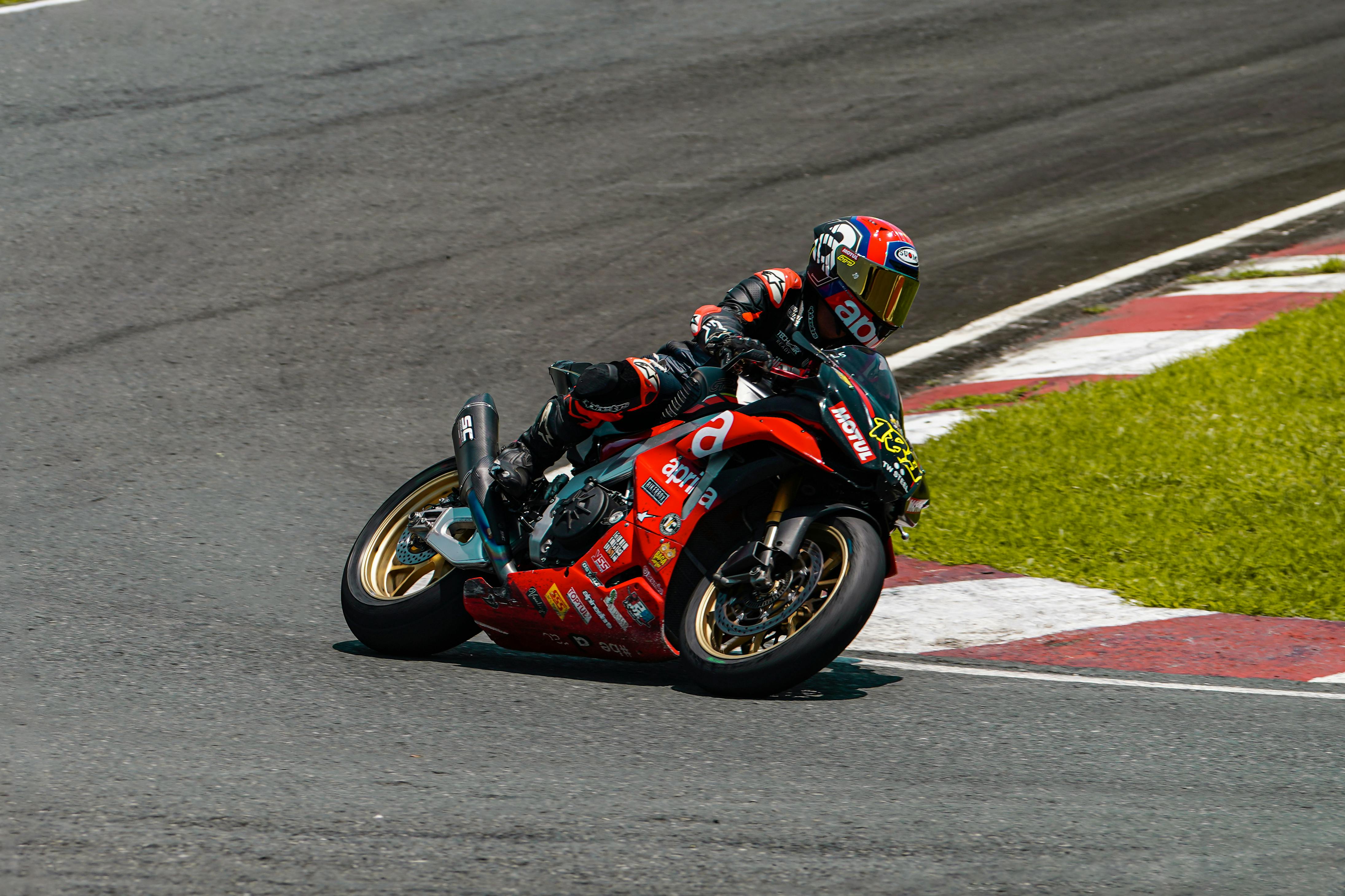 A person riding a motorcycle on a race track · Free Stock Photo