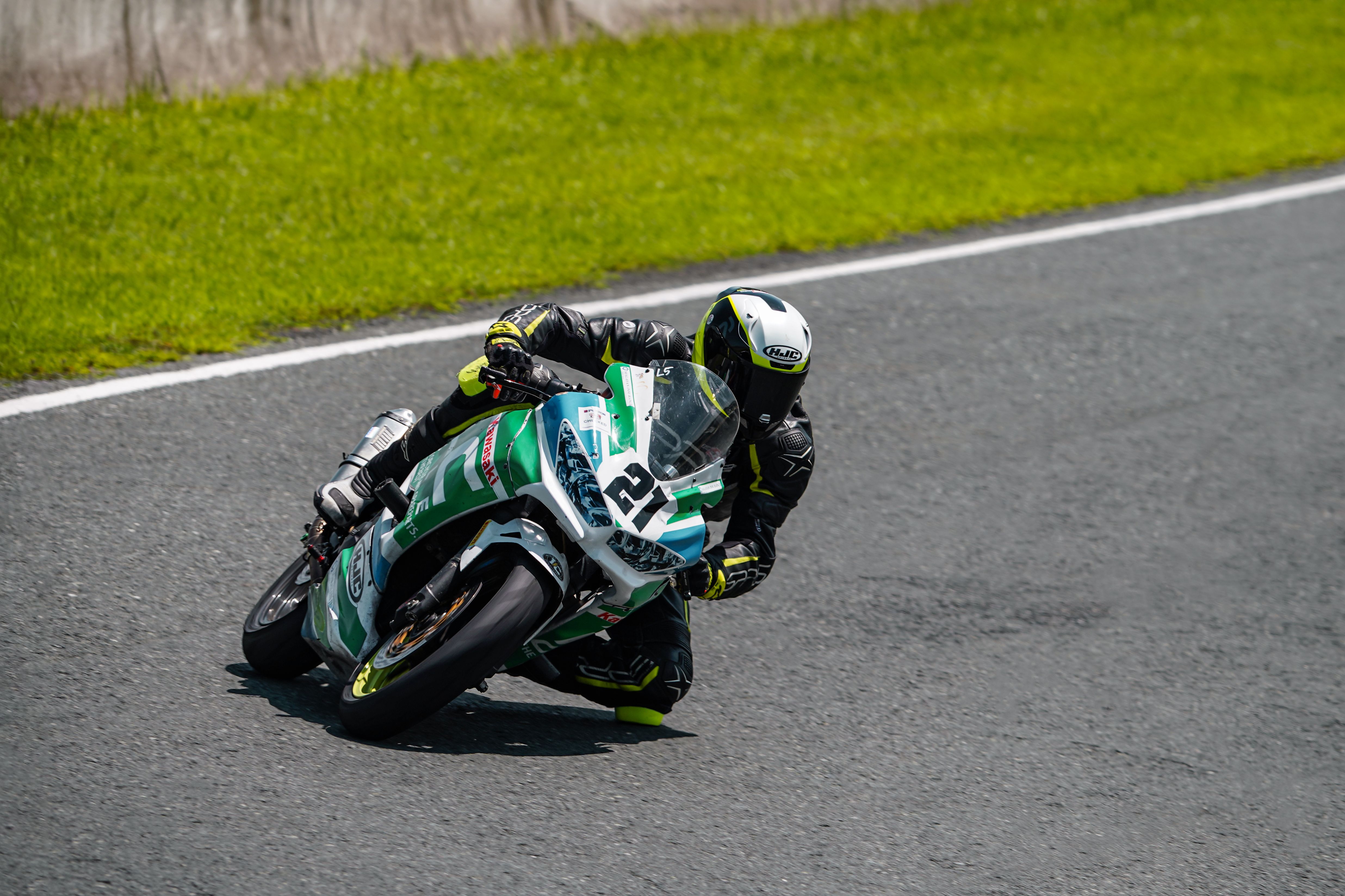 A person riding a motorcycle on a race track · Free Stock Photo