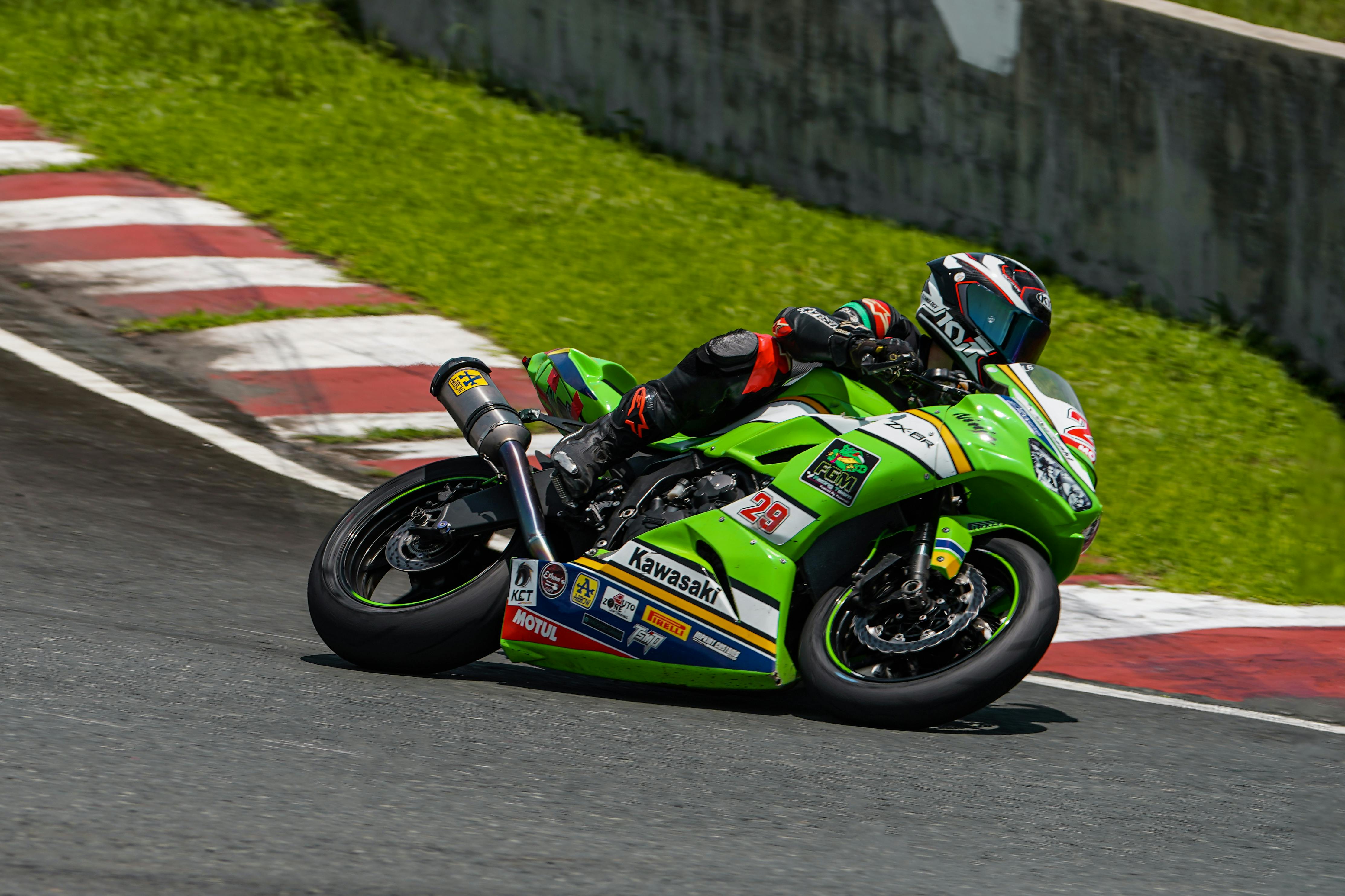 A person riding a motorcycle on a track · Free Stock Photo