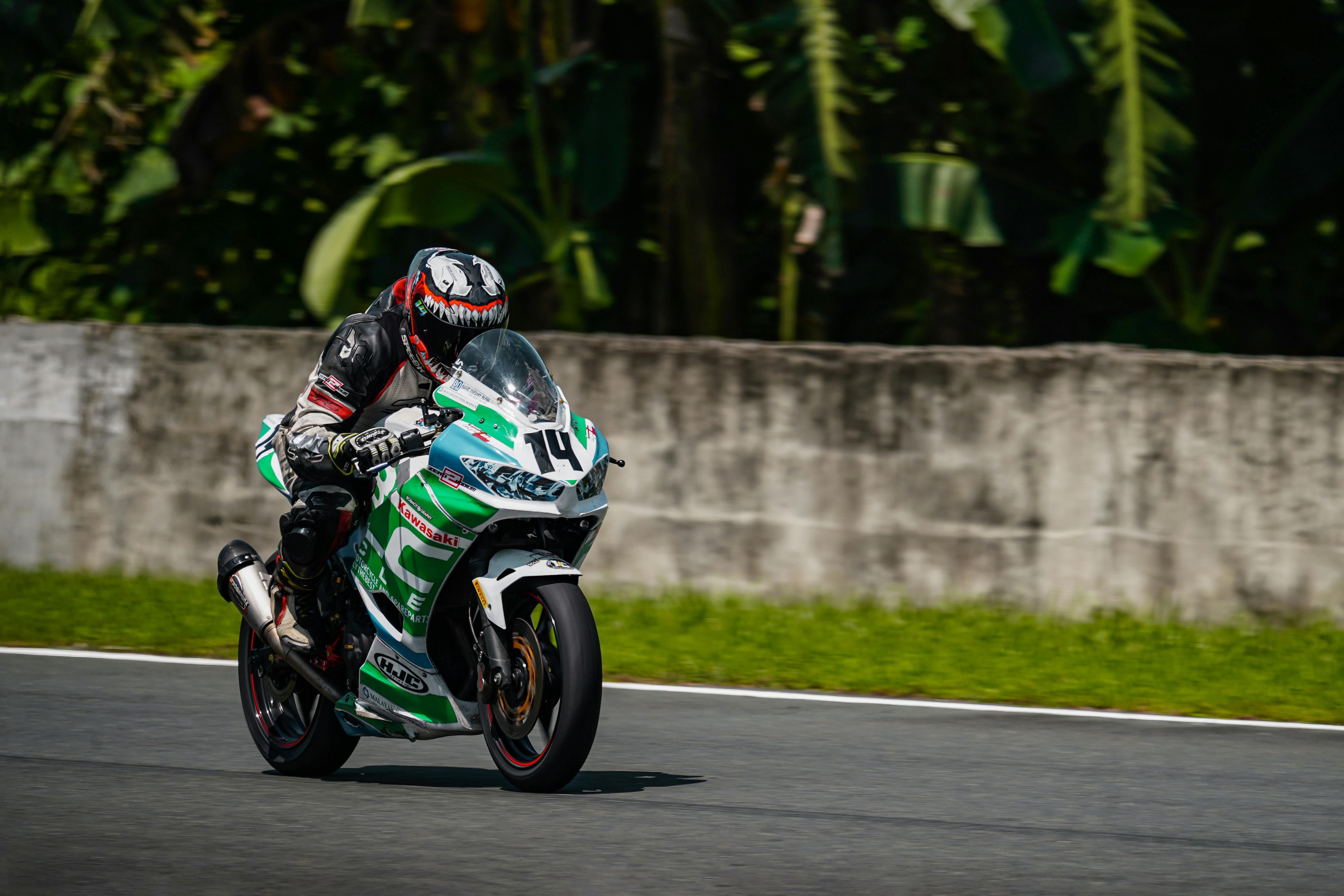 A person riding a motorcycle on a track · Free Stock Photo