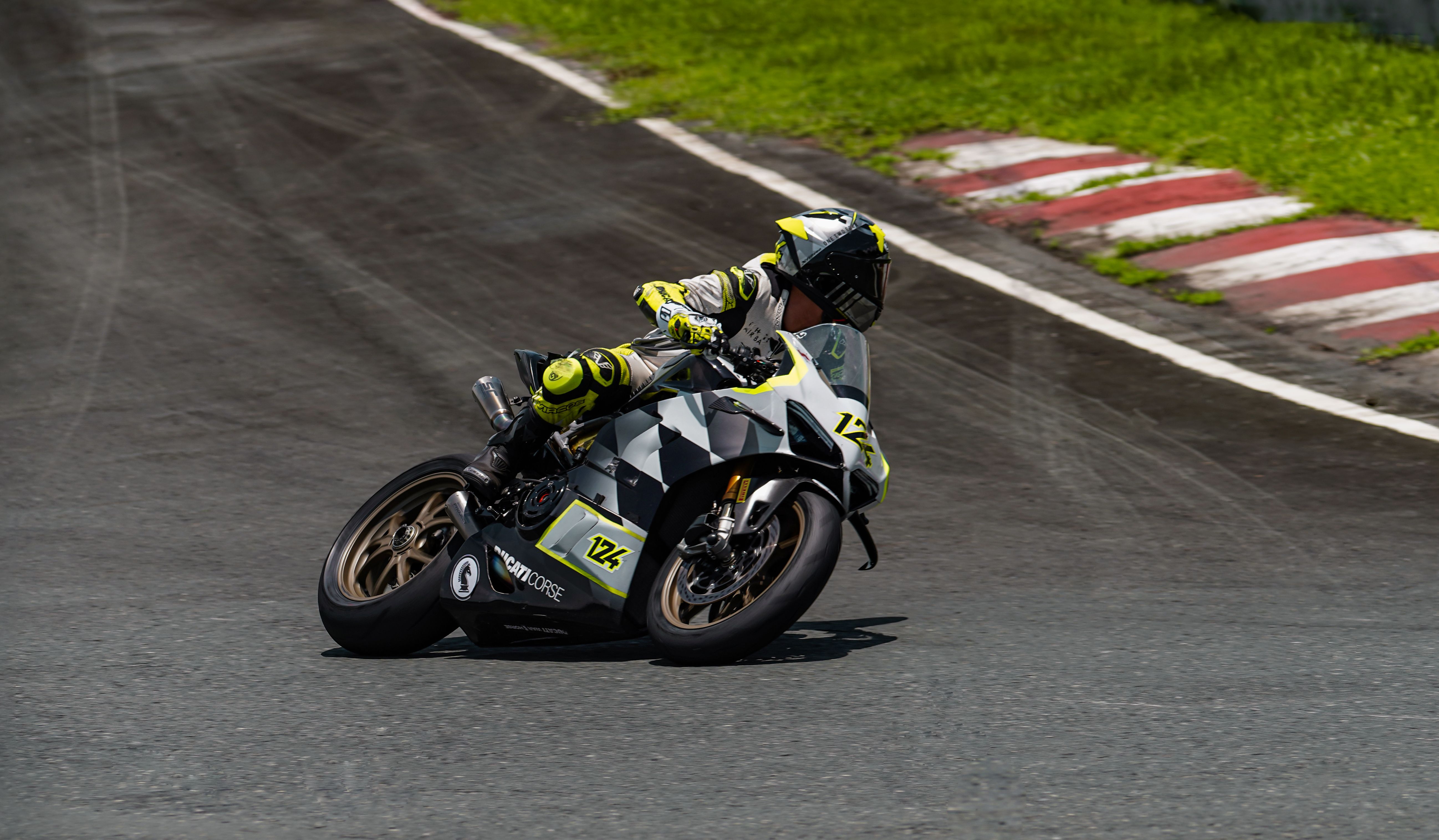 A person riding a motorcycle on a race track · Free Stock Photo