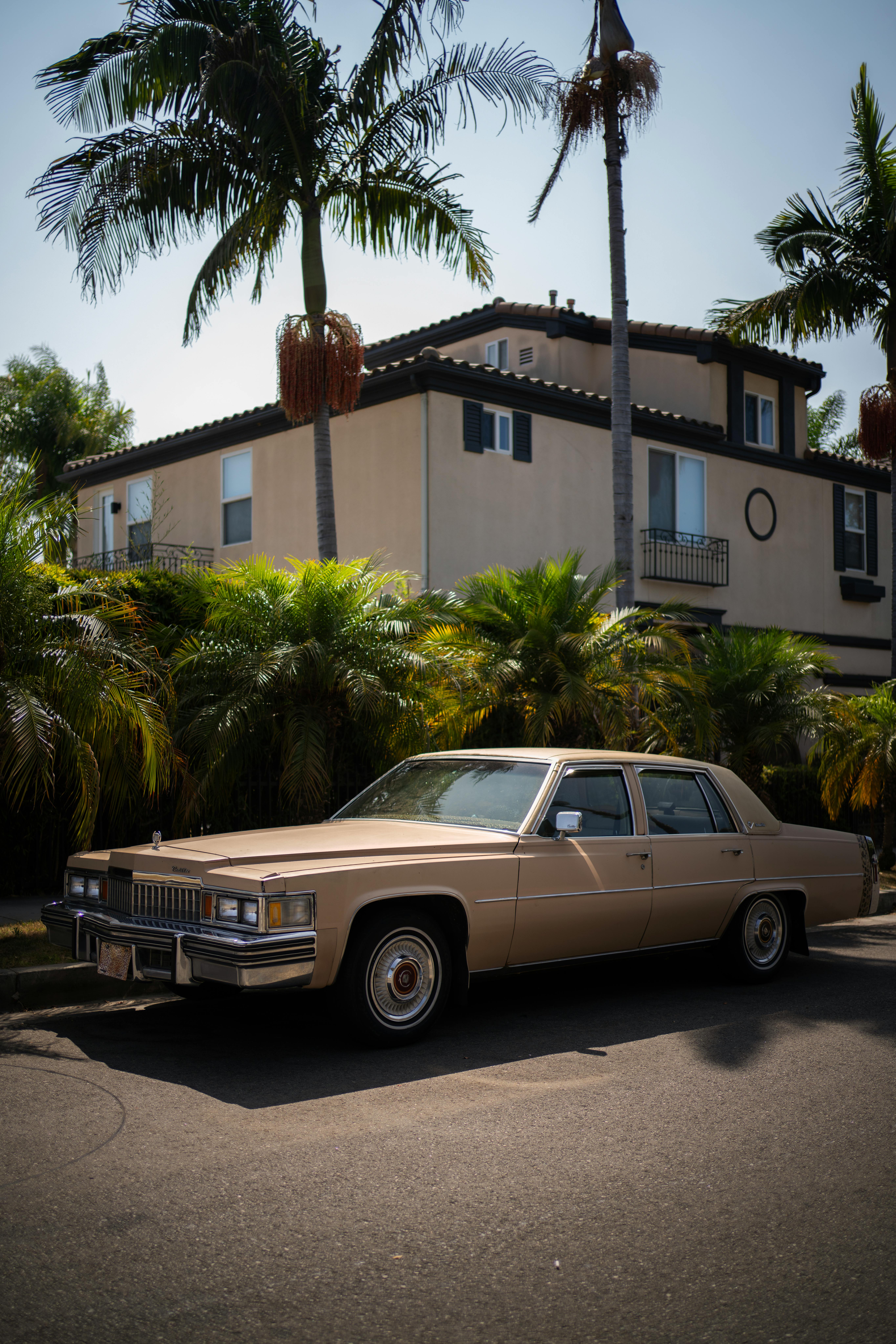 A tan car parked in front of a house · Free Stock Photo