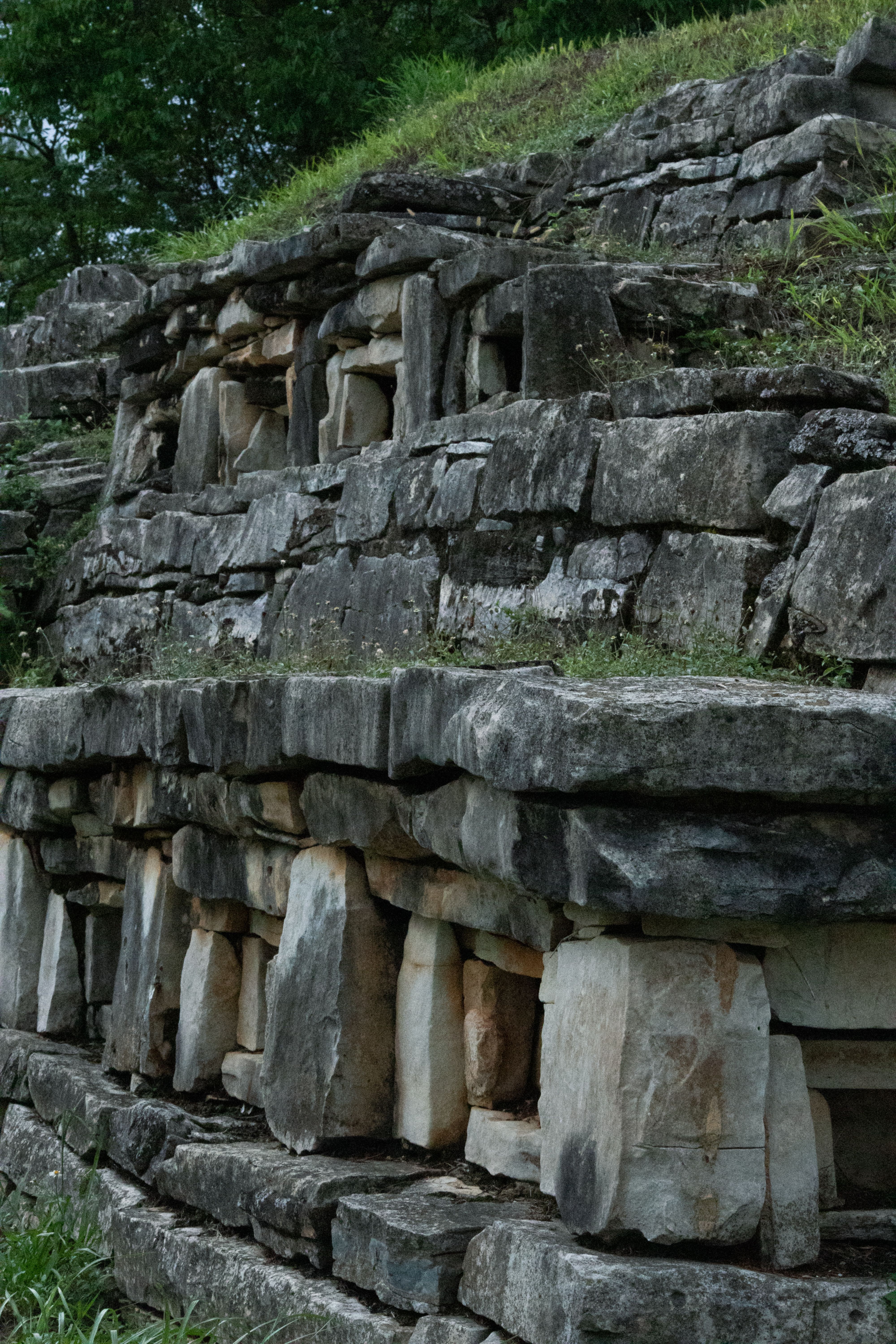 The ruins of a stone structure with a green grassy area · Free Stock Photo