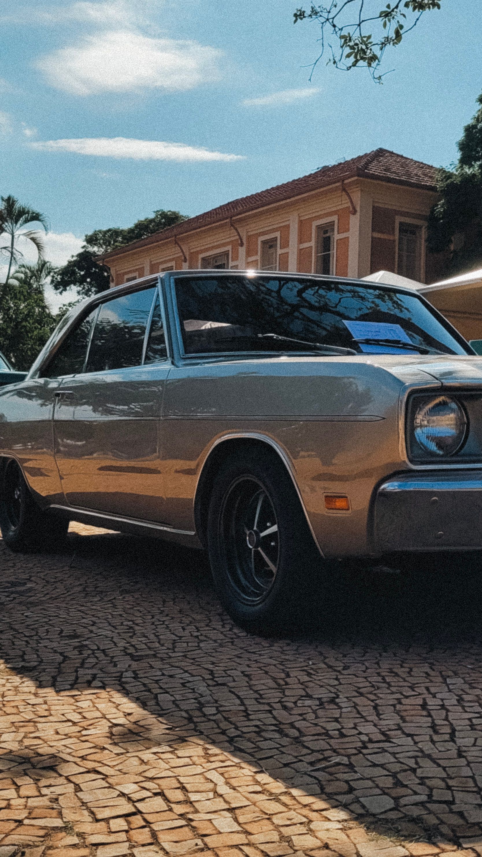 A classic car parked in front of a brick building · Free Stock Photo