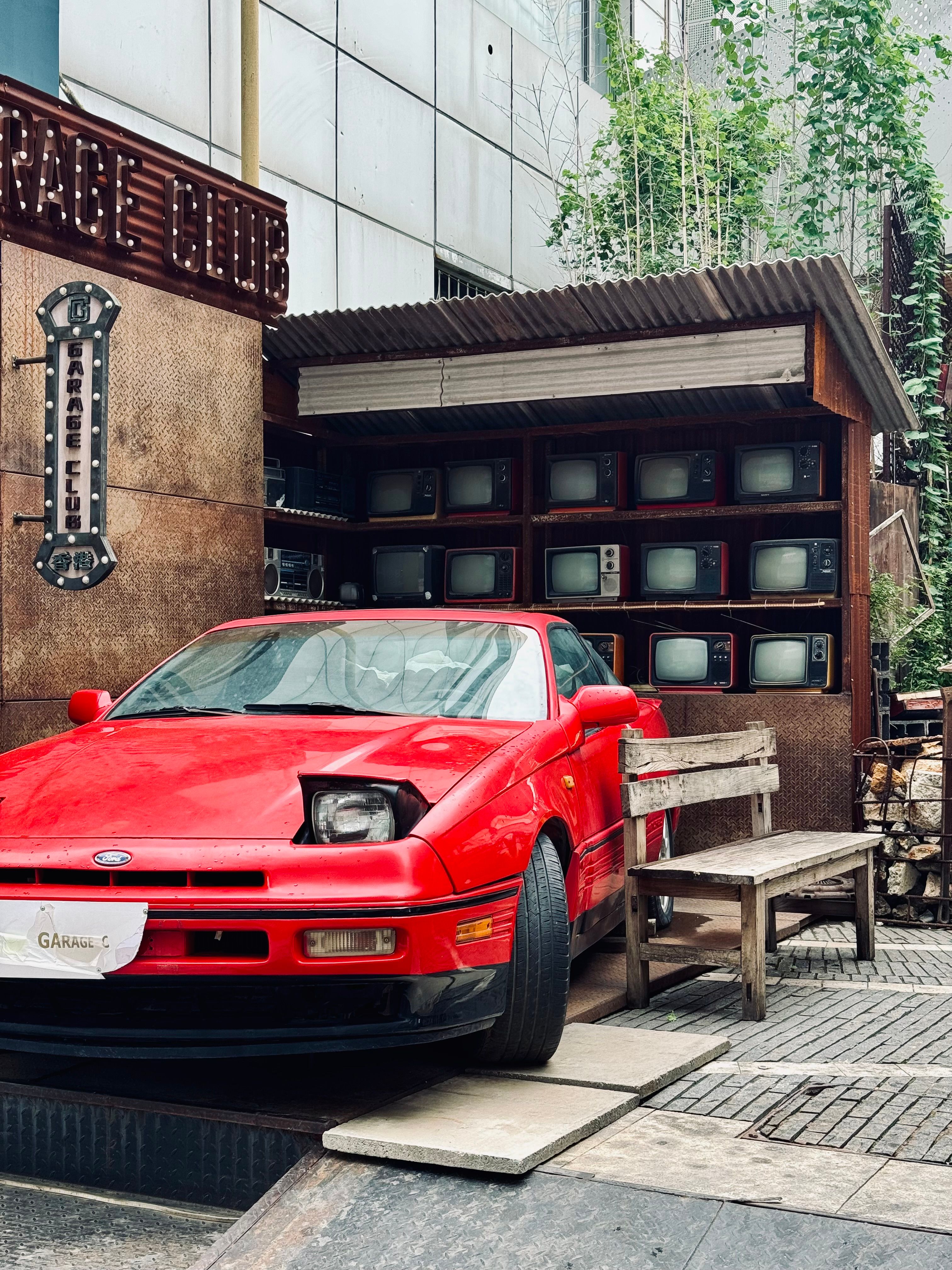 A red car parked in front of a restaurant · Free Stock Photo