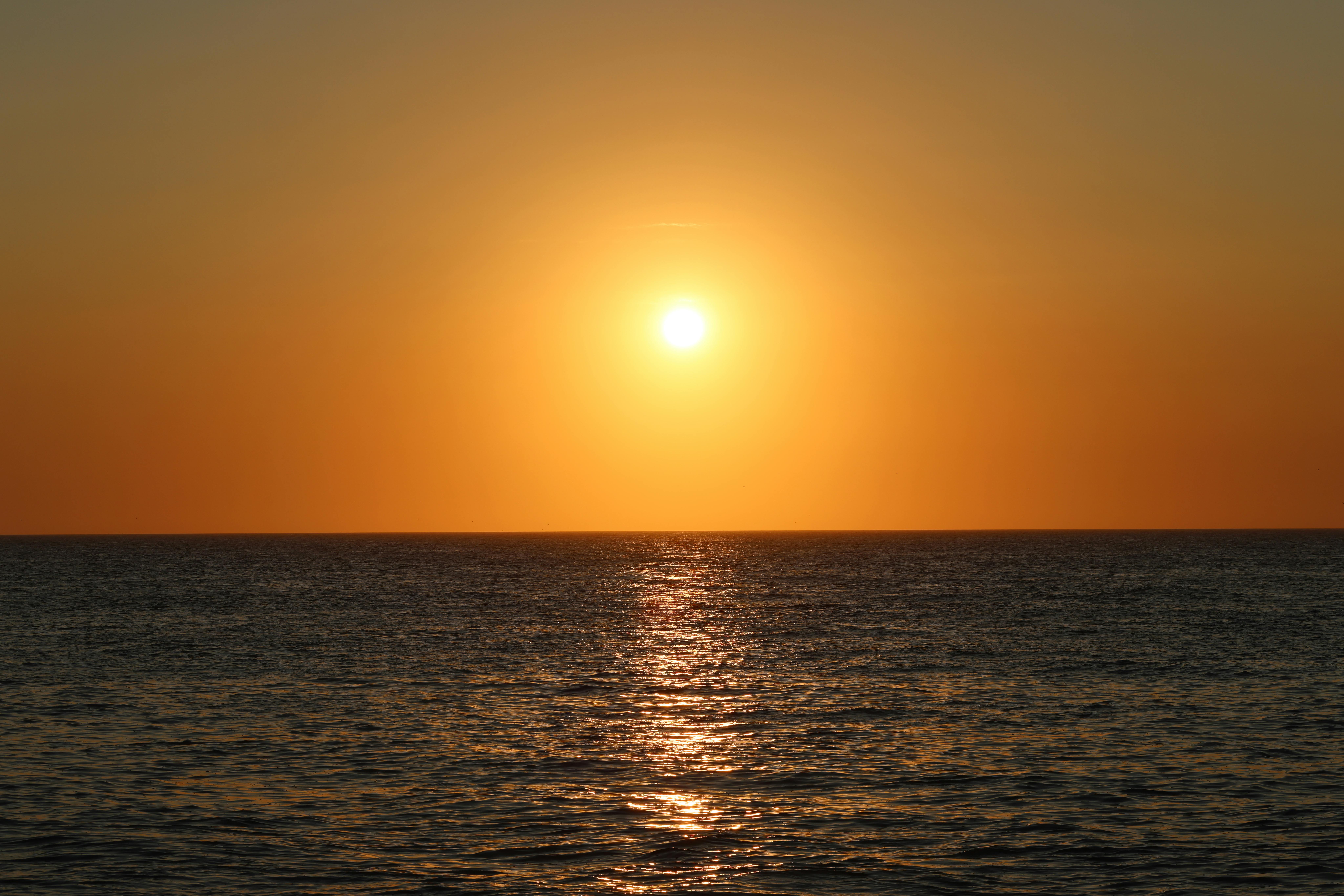 Blurred Sun over Dark Ocean · Free Stock Photo