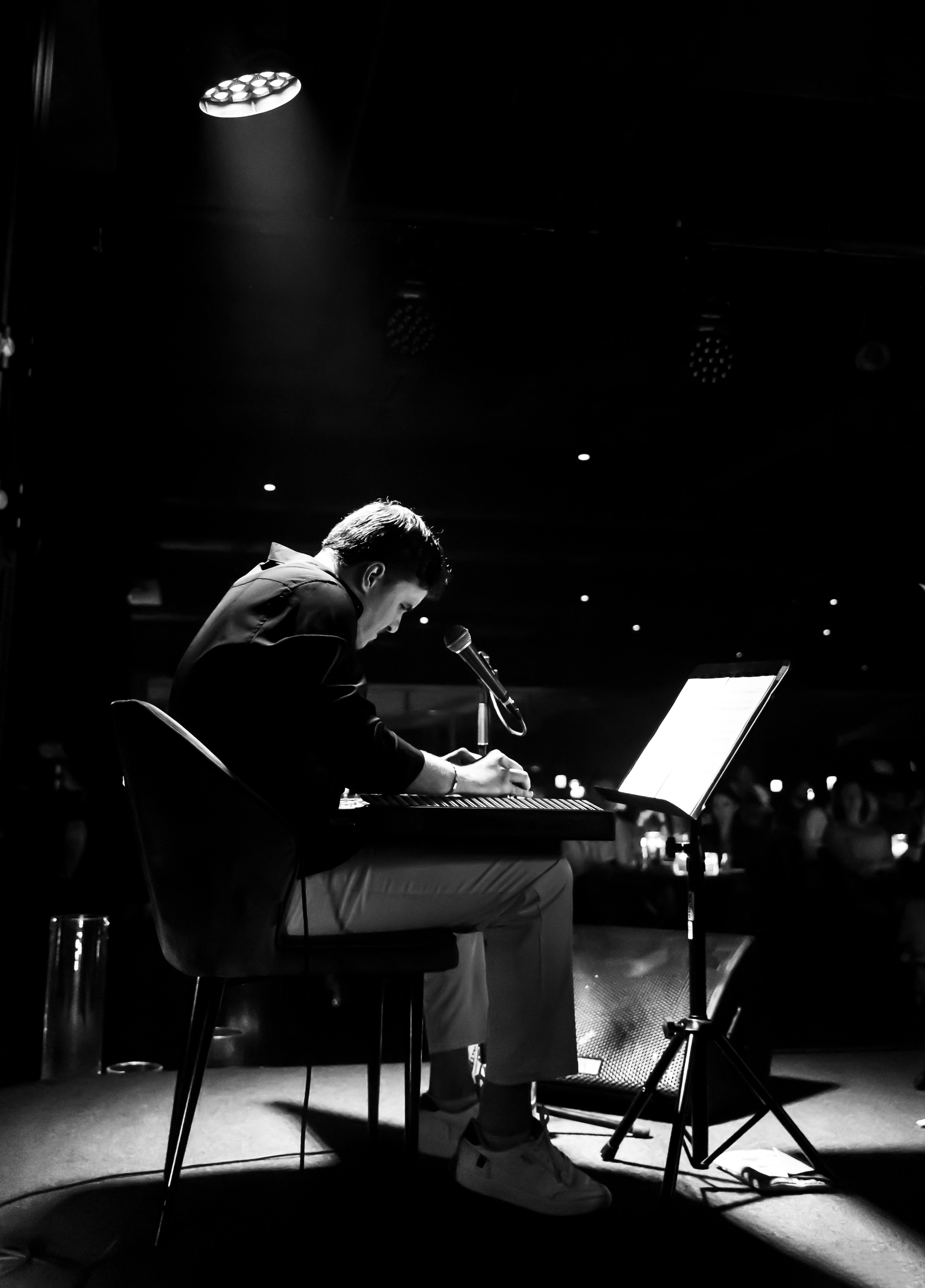 Solo Musician Performing in Dimly Lit Club · Free Stock Photo