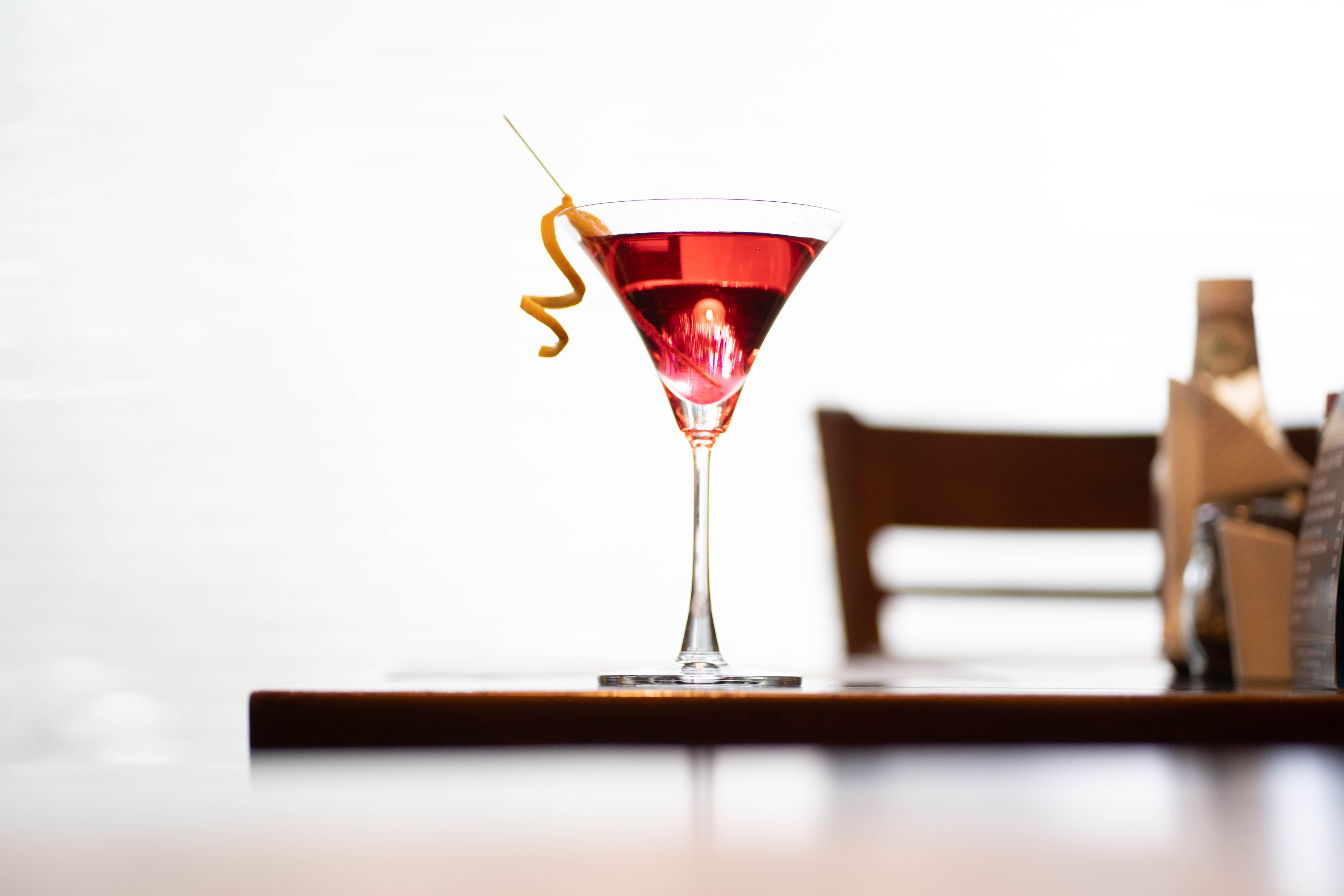 cocktail topped with lime slice Single glass of dry martini in a ...