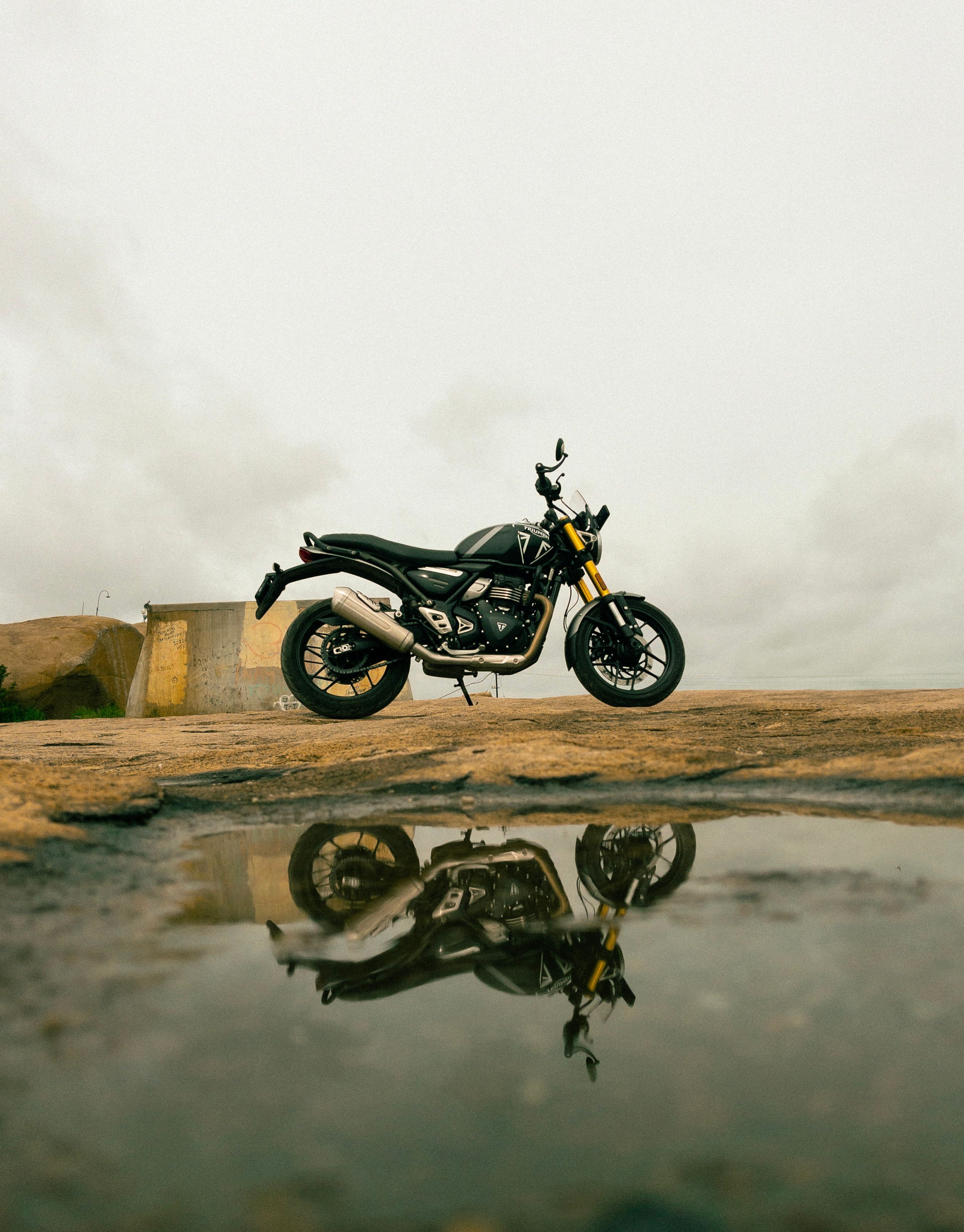 Motorcycle Reflection on Wet Pavement Outdoors · Free Stock Photo