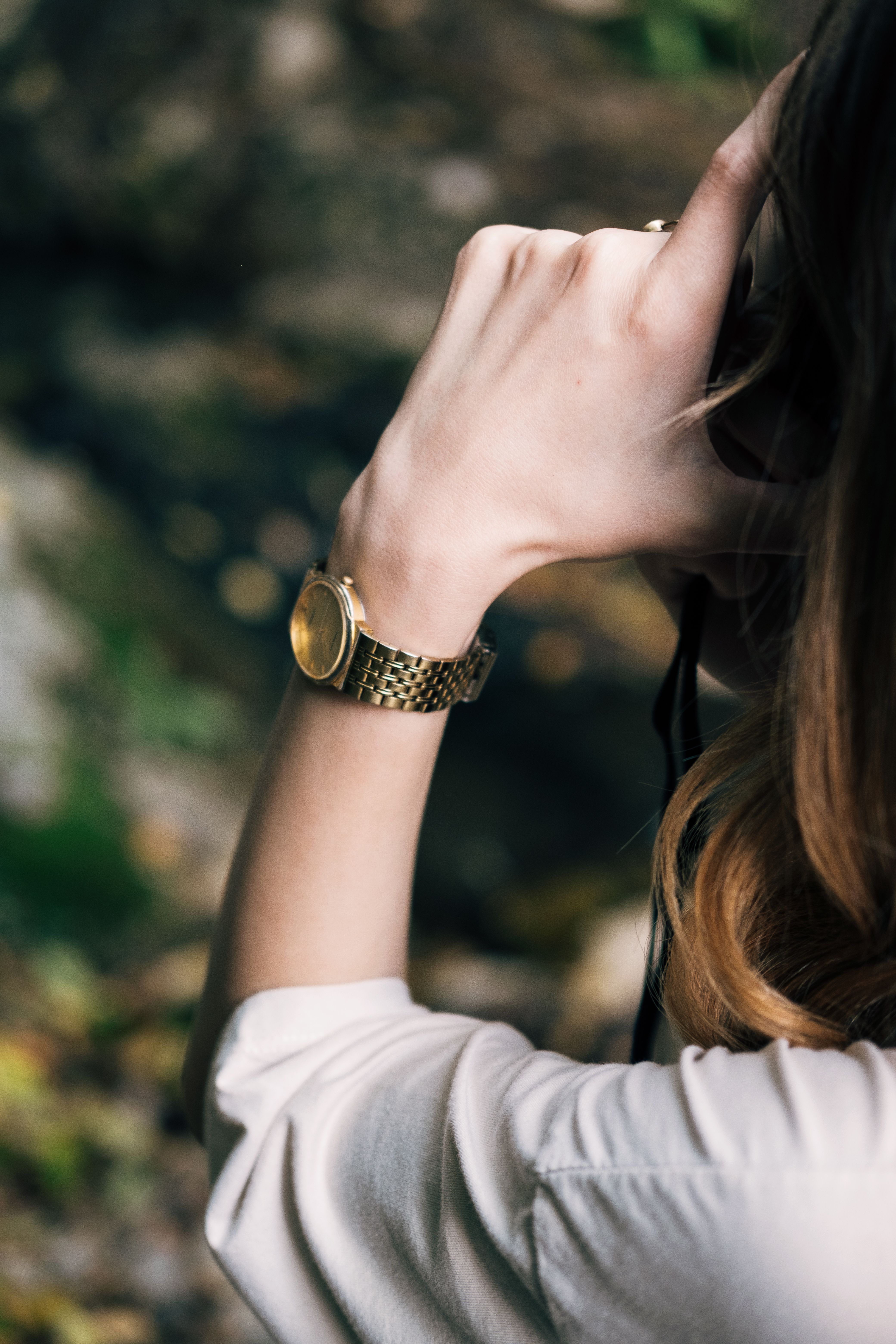 A woman is looking at her watch while taking a picture · Free Stock Photo