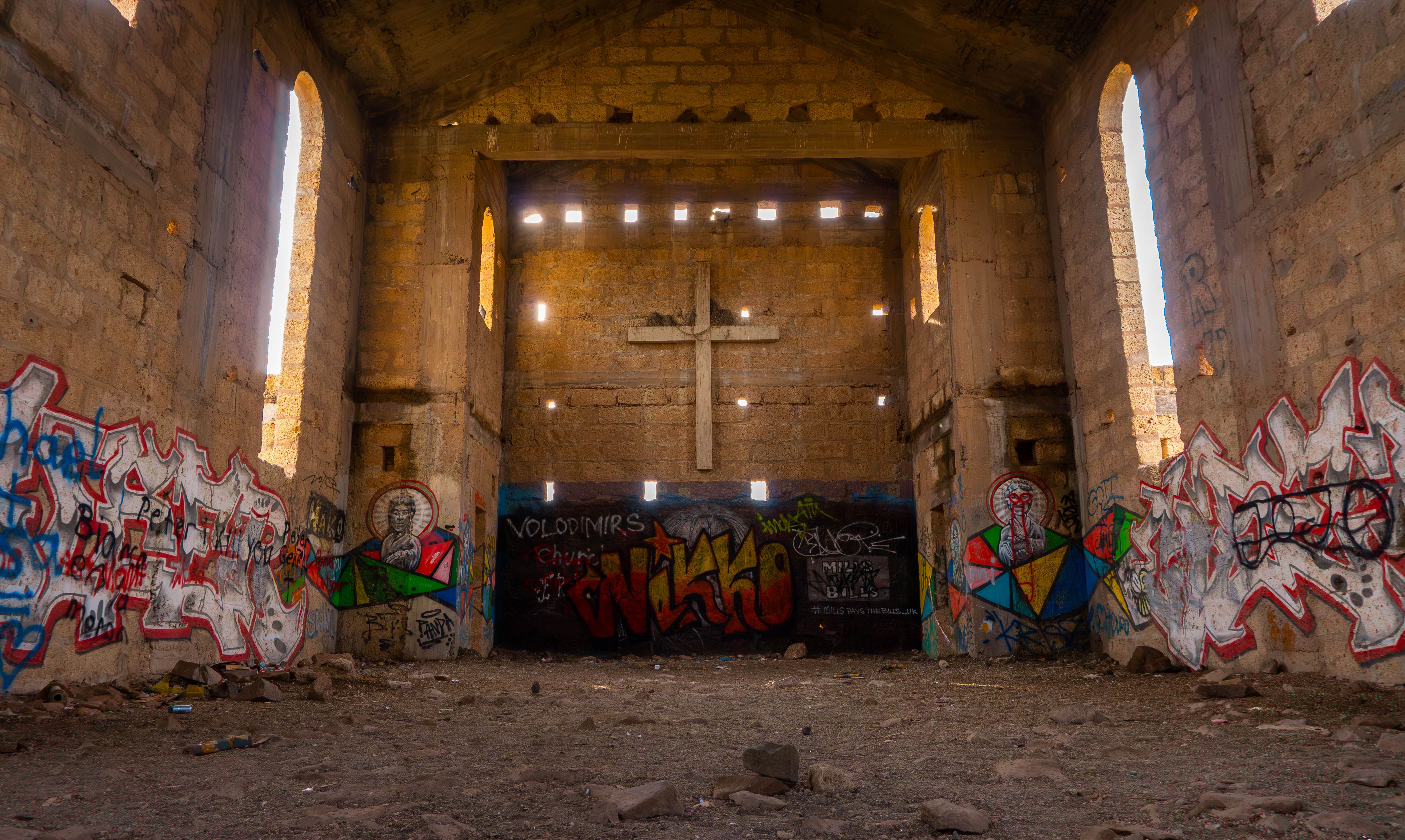 A church with graffiti on the walls and a cross · Free Stock Photo