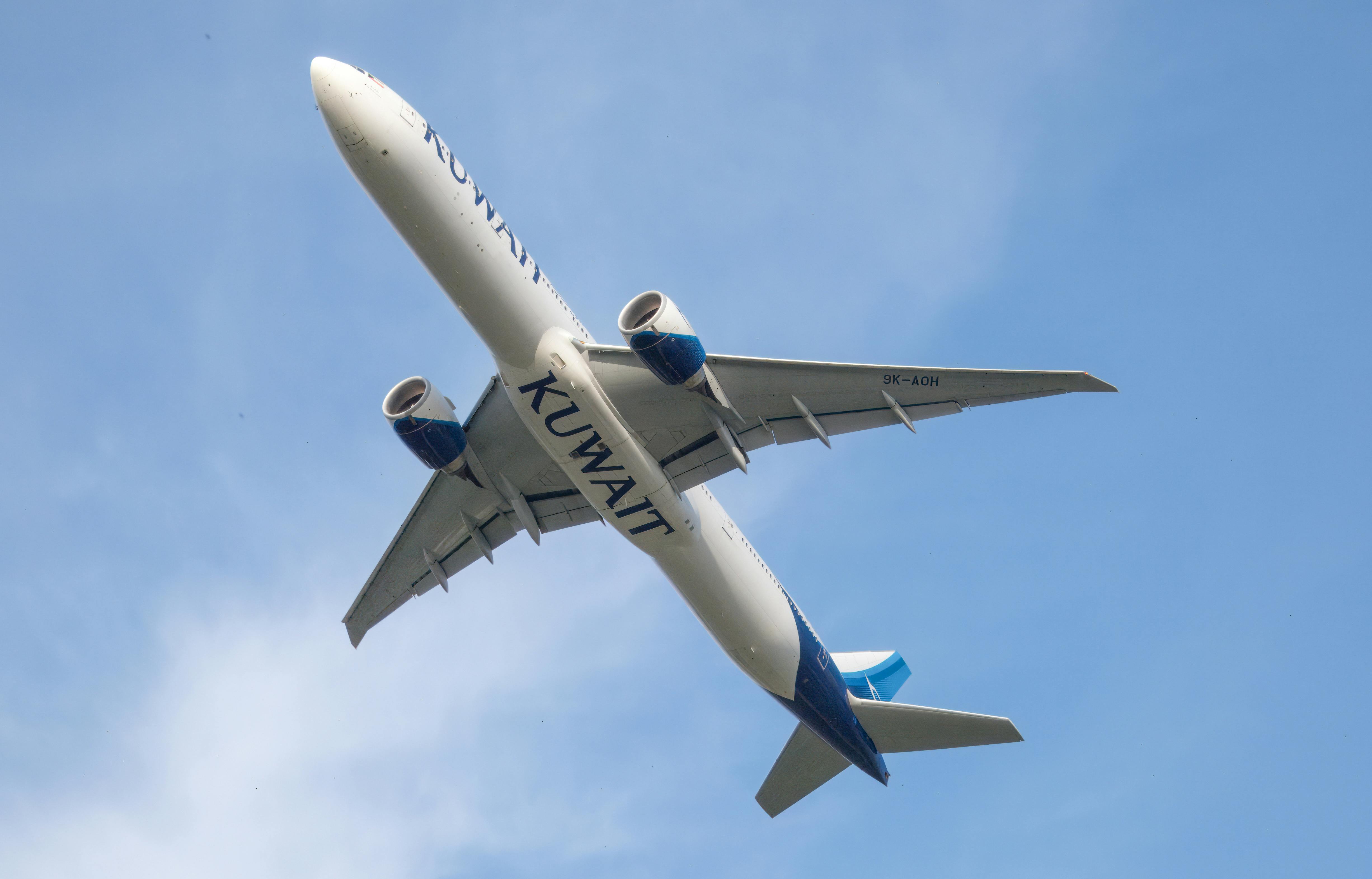 Kuwait Airways Plane Mid-Flight Against Blue Sky · Free Stock Photo