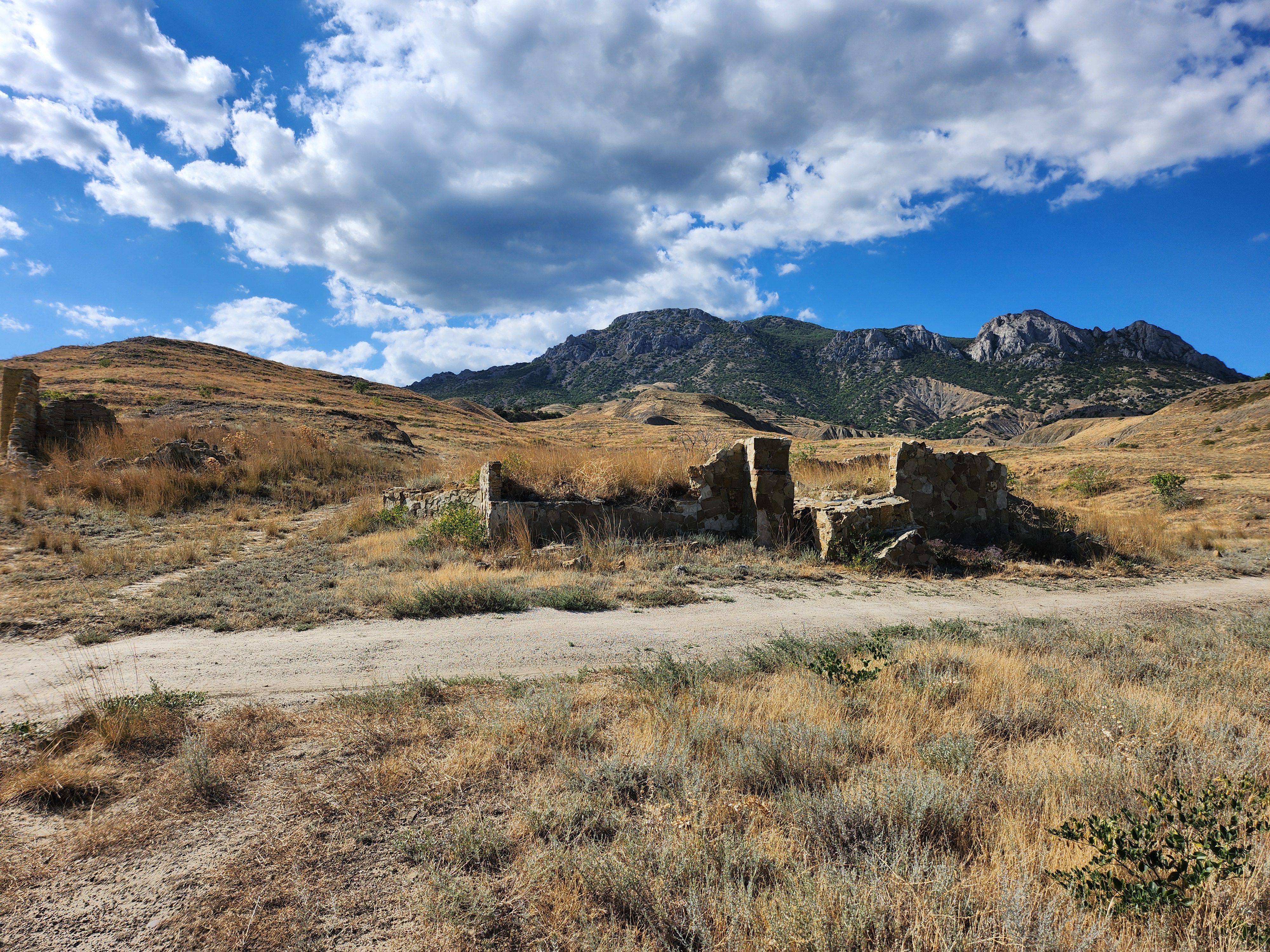 Landscape Featuring Ancient Ruins Amidst Mountain Backdrop · Free Stock ...