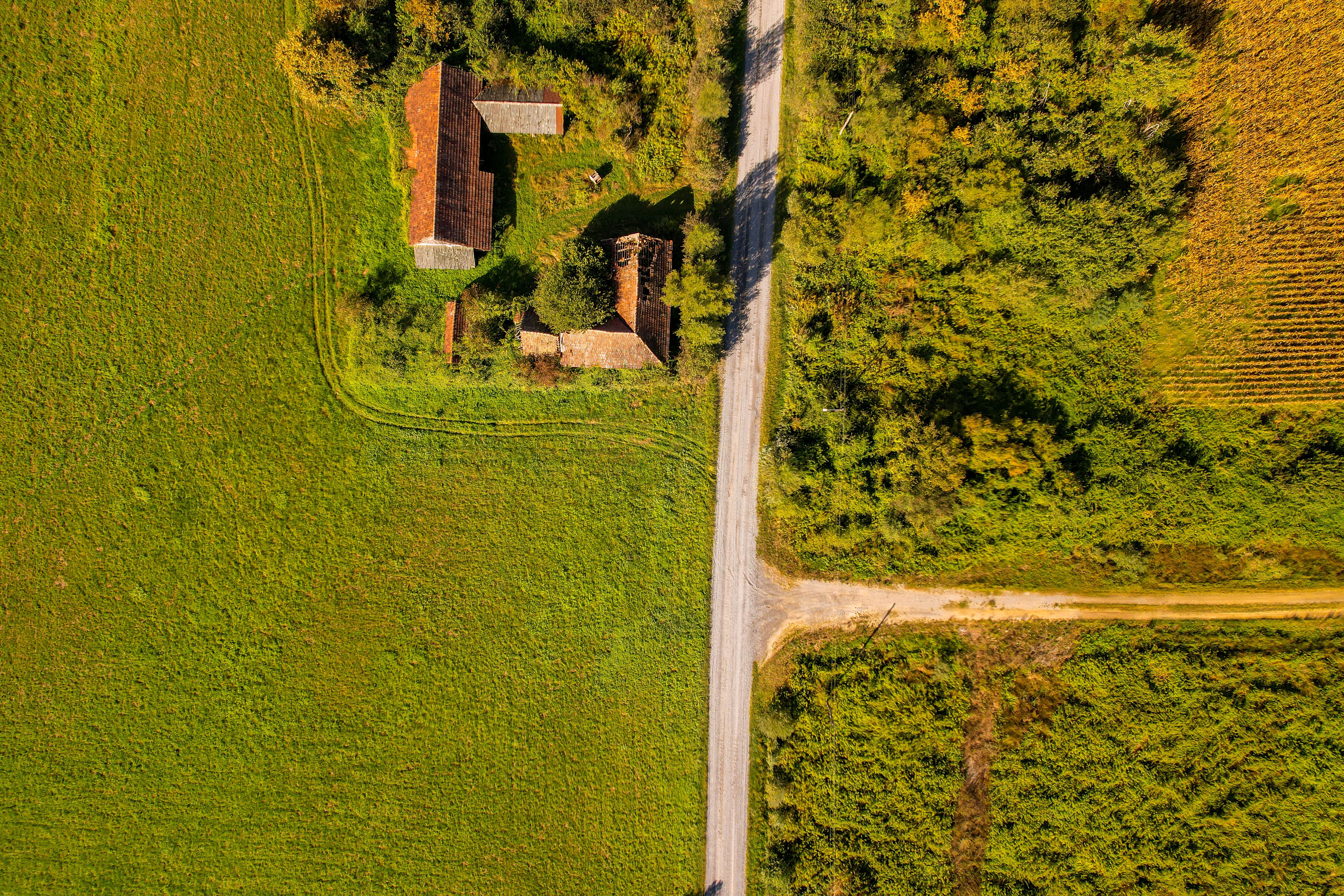 Aerial View of a Farmhouse by a Country Road · Free Stock Photo