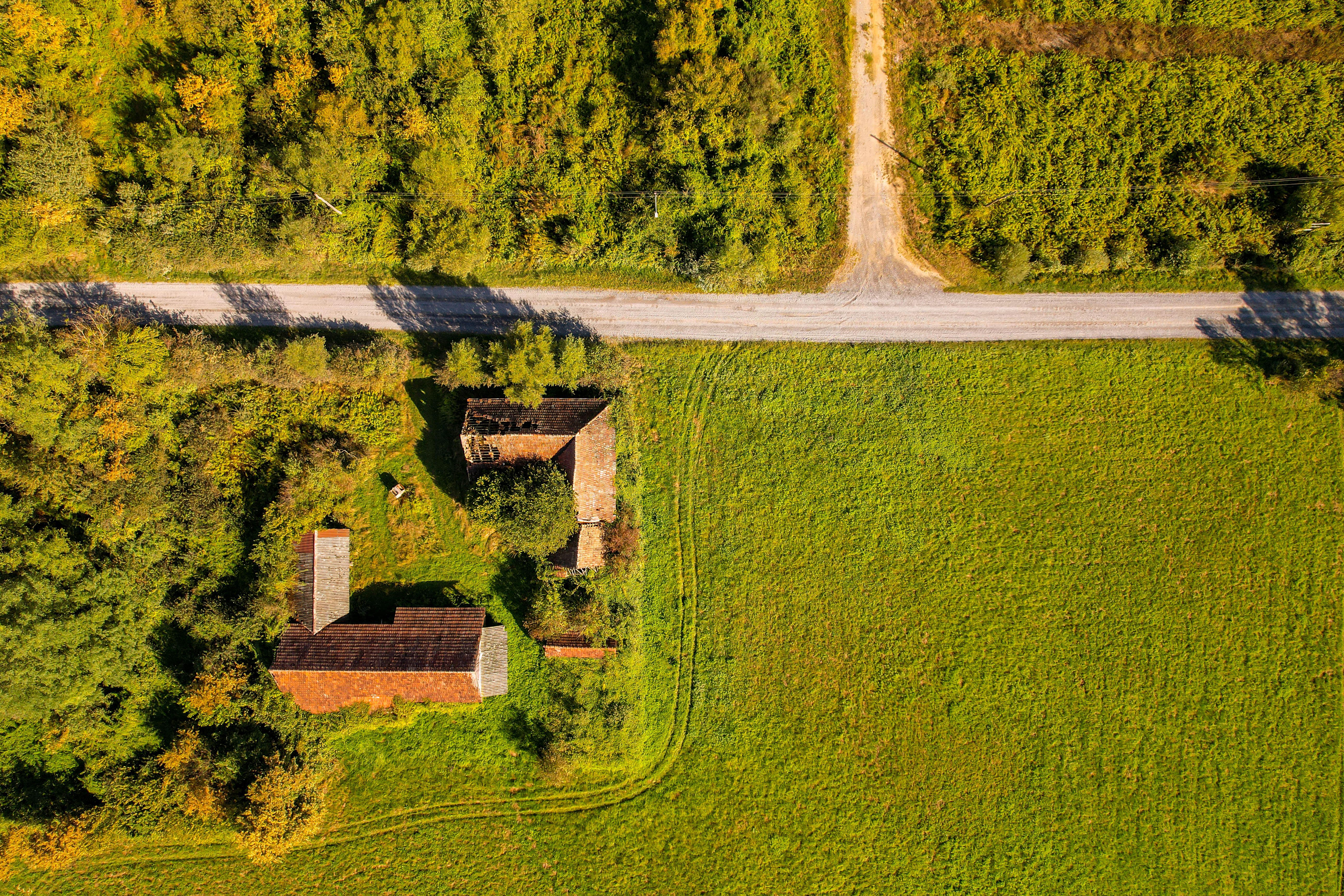 Aerial View of a Farmhouse by a Country Road · Free Stock Photo