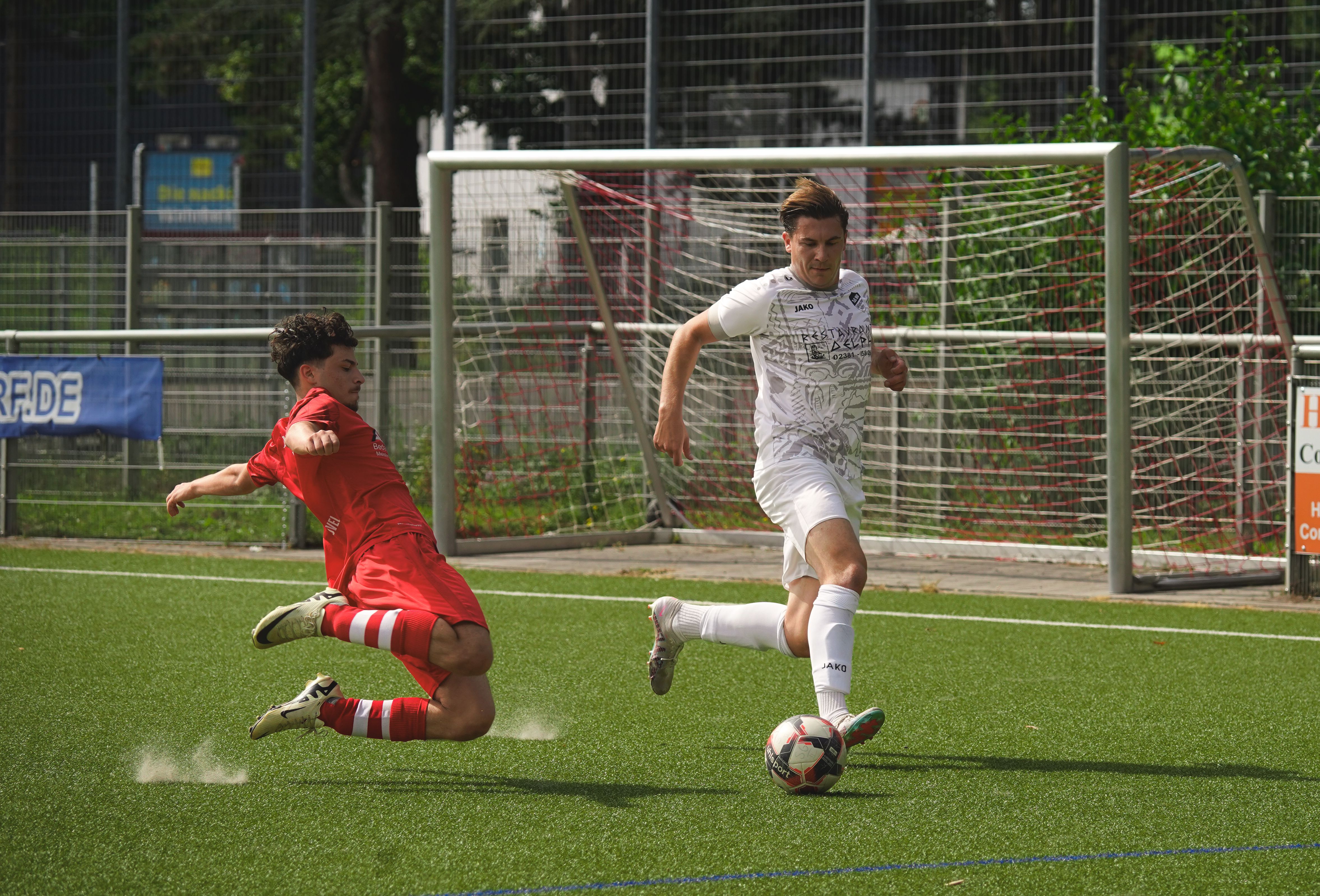 Two Young Men Running After Ball on a Football Pitch · Free Stock Photo