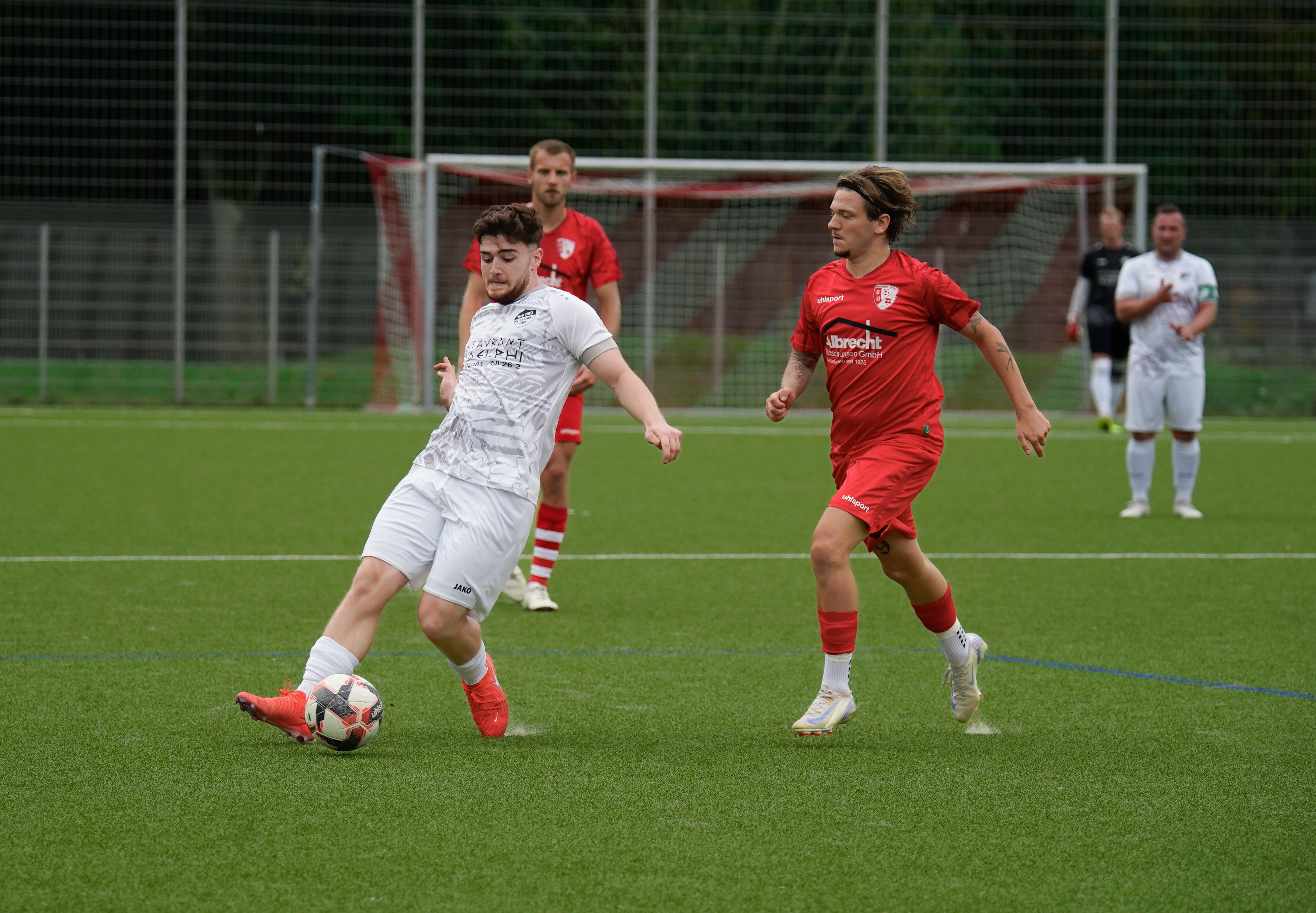Footballers Playing on Football Pitch · Free Stock Photo