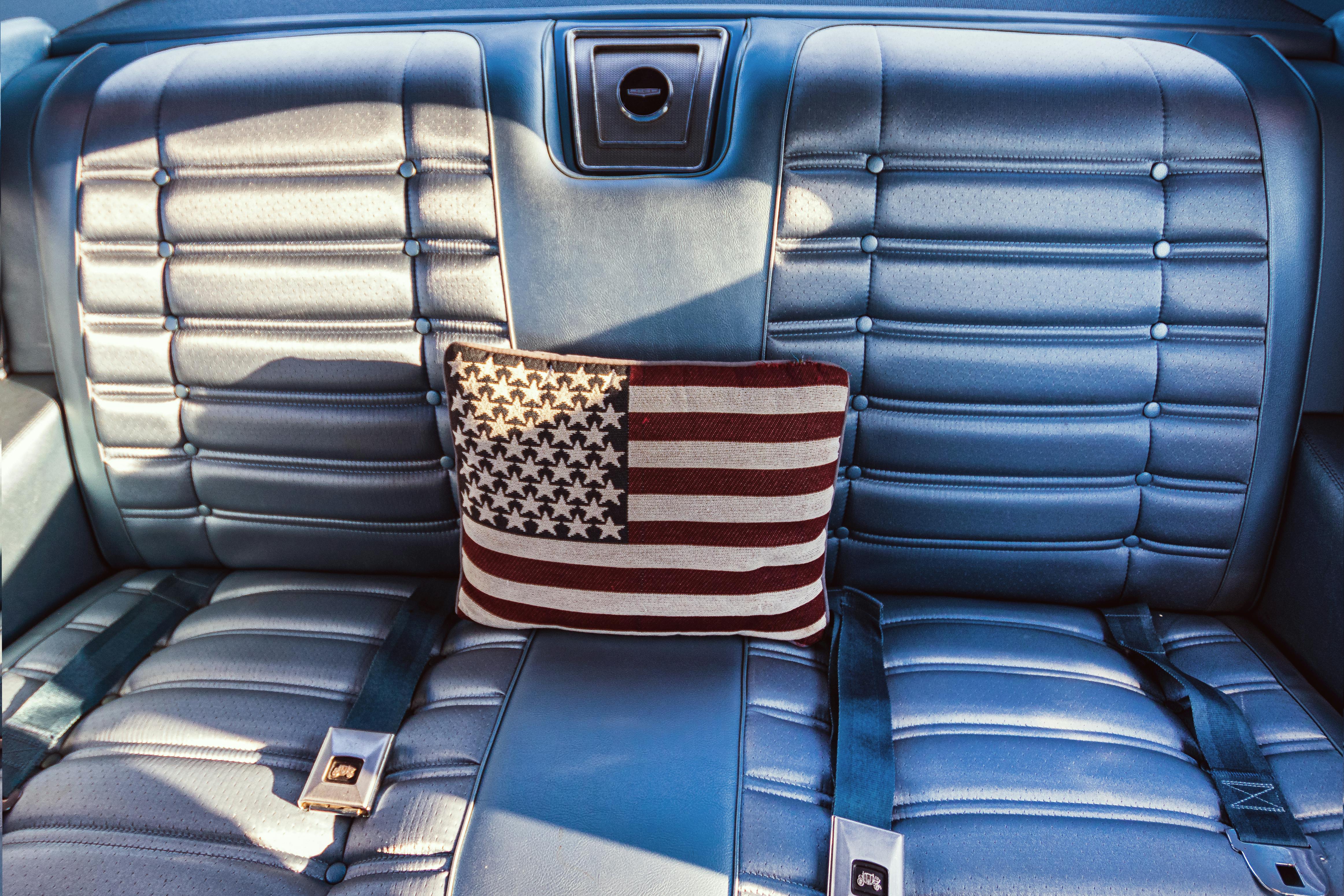 Vintage Blue Car Interior with American Flag Decor · Free Stock Photo