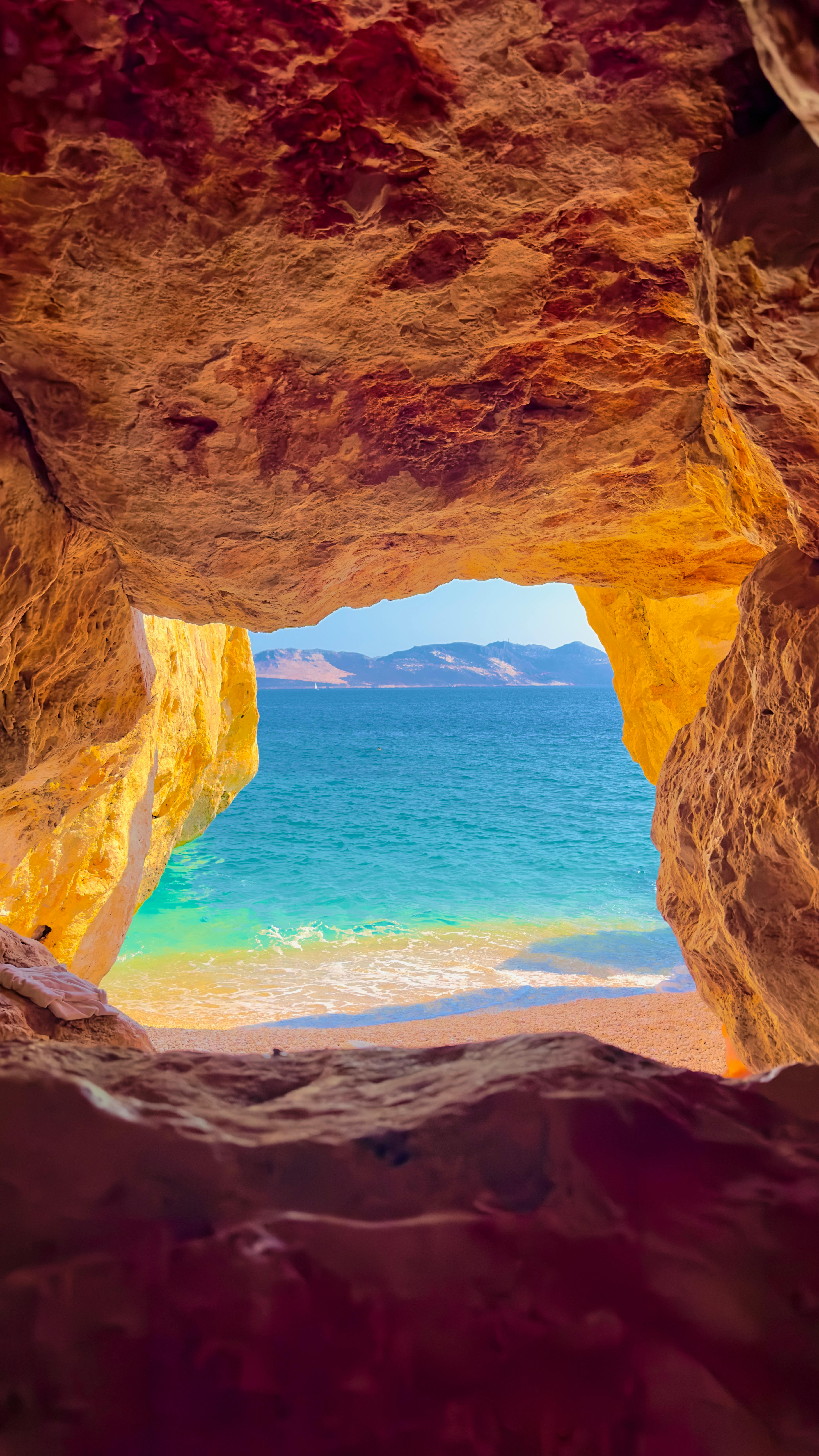 View of Beach and Seashore From Cave · Free Stock Photo