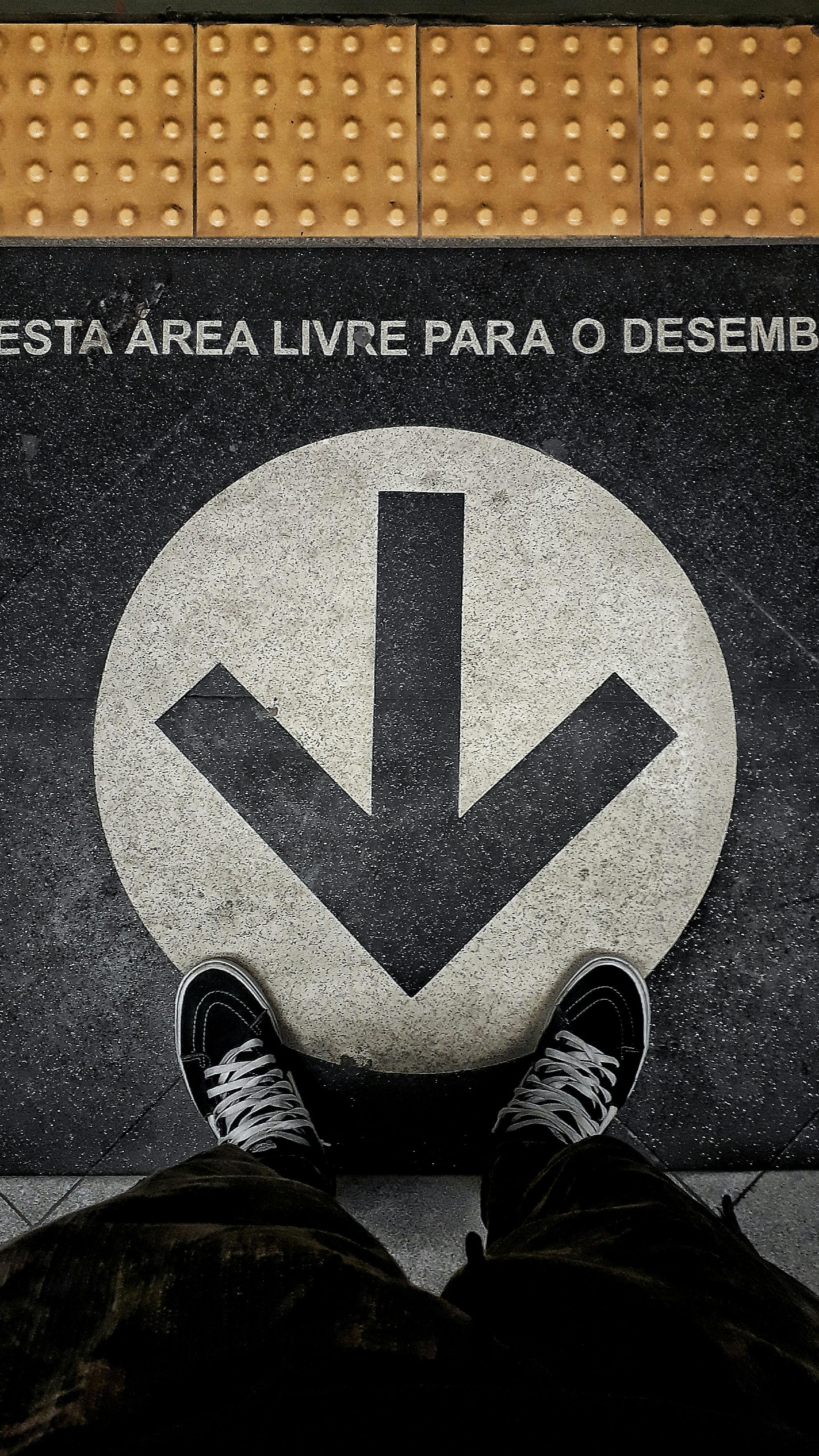 Person Standing On Arrow · Free Stock Photo