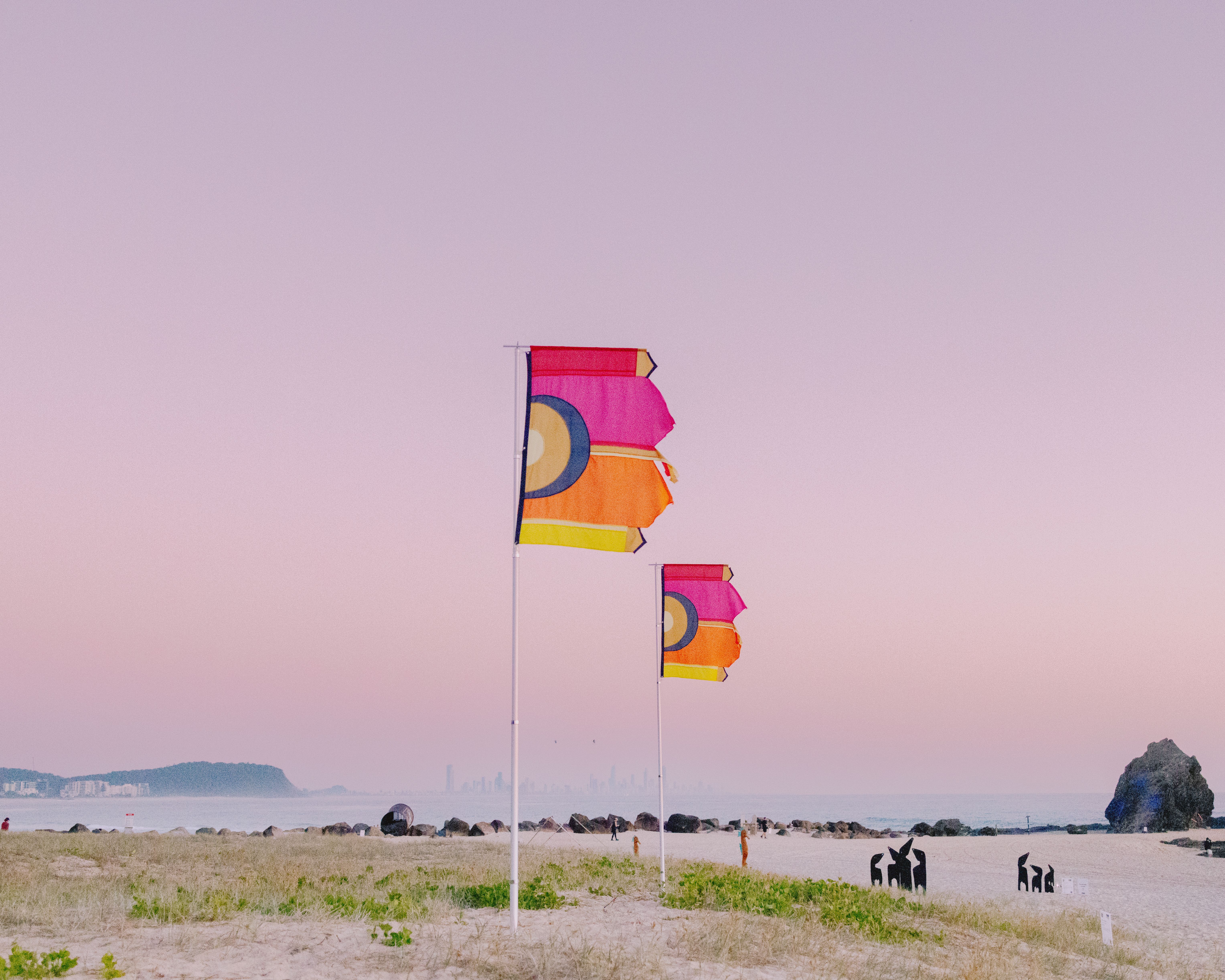 Colorful Flags on the Beach at Sunset · Free Stock Photo