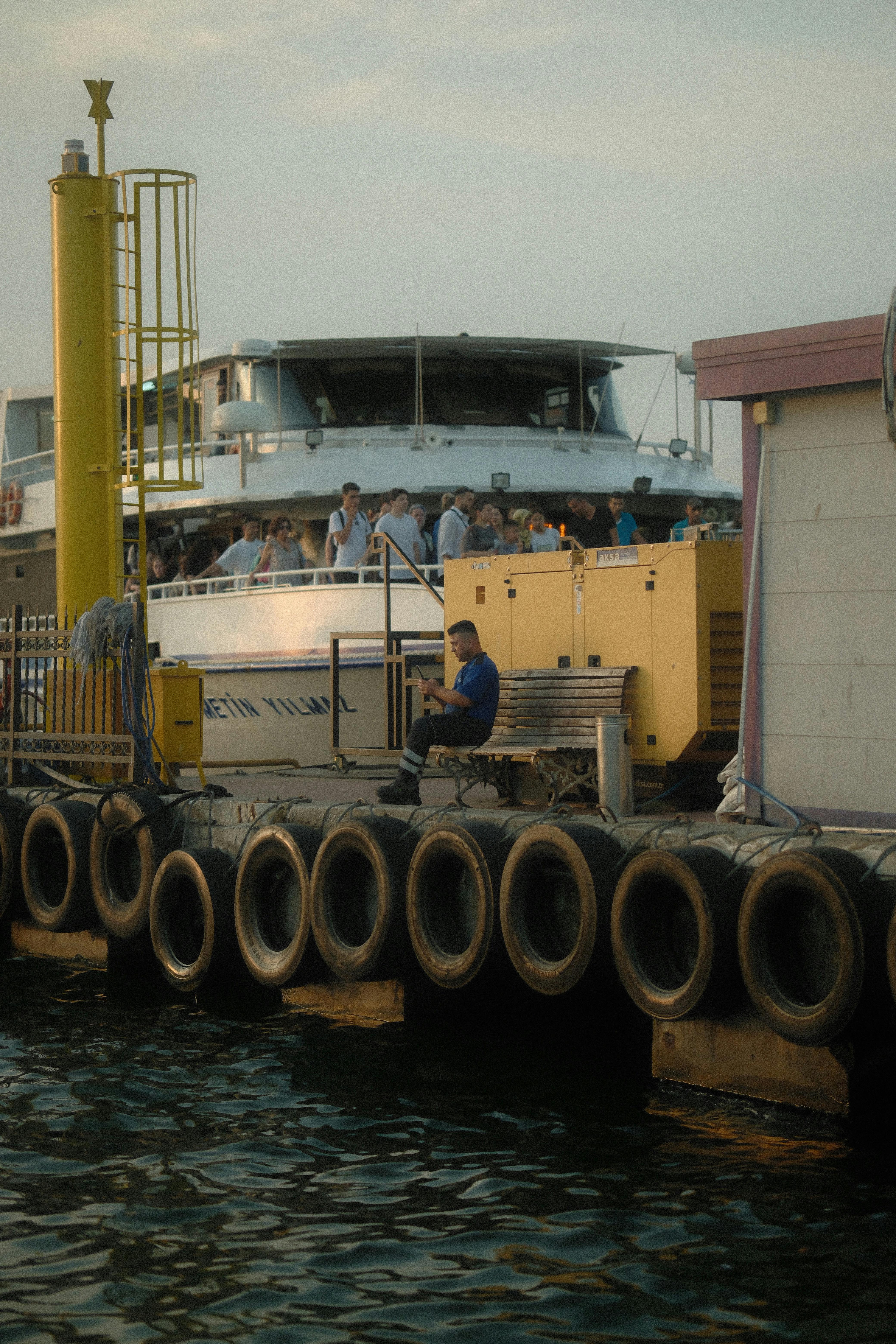Busy Dock with Passenger Ferry at Sunset · Free Stock Photo