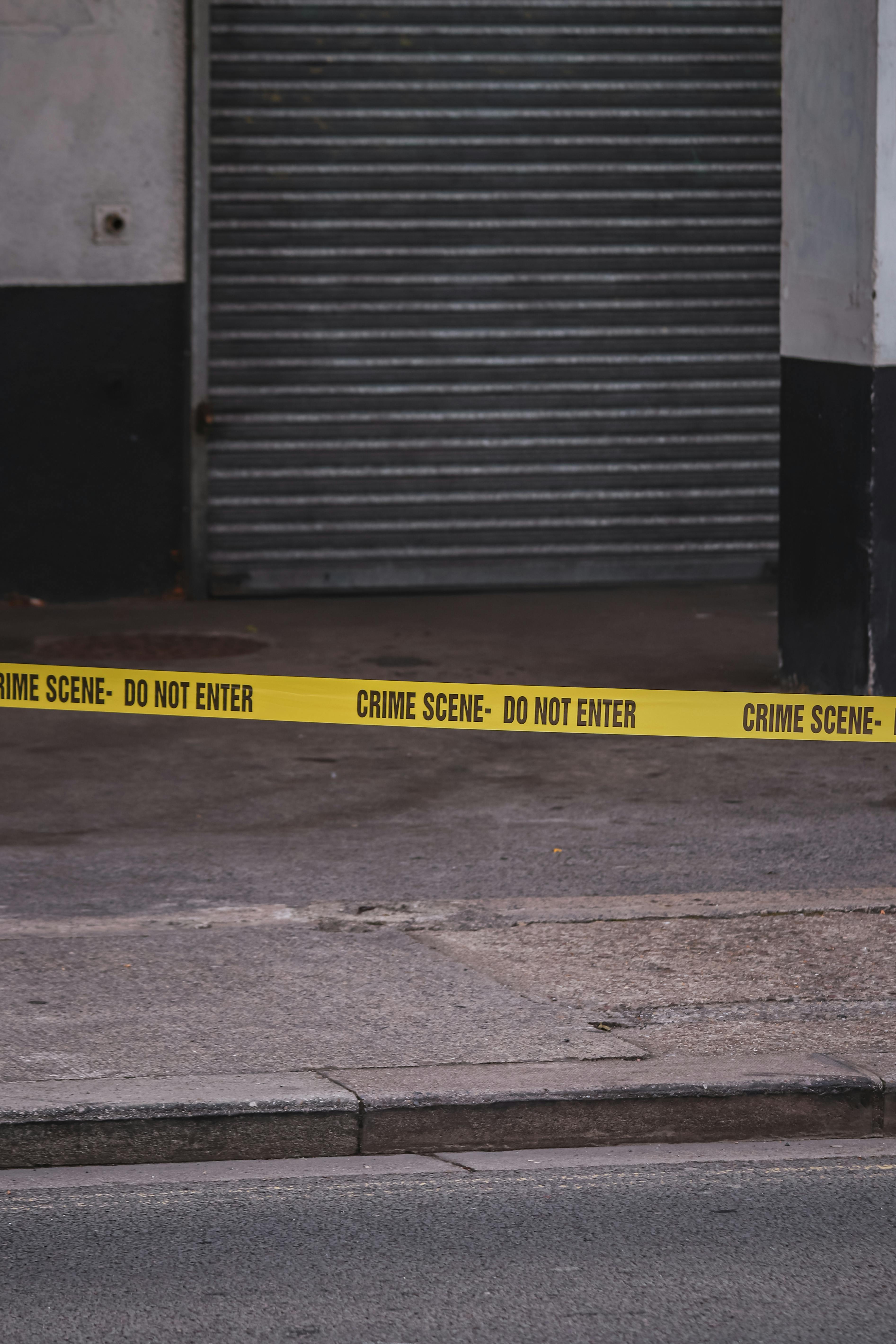 Yellow Crime Scene Tape over Sidewalk · Free Stock Photo