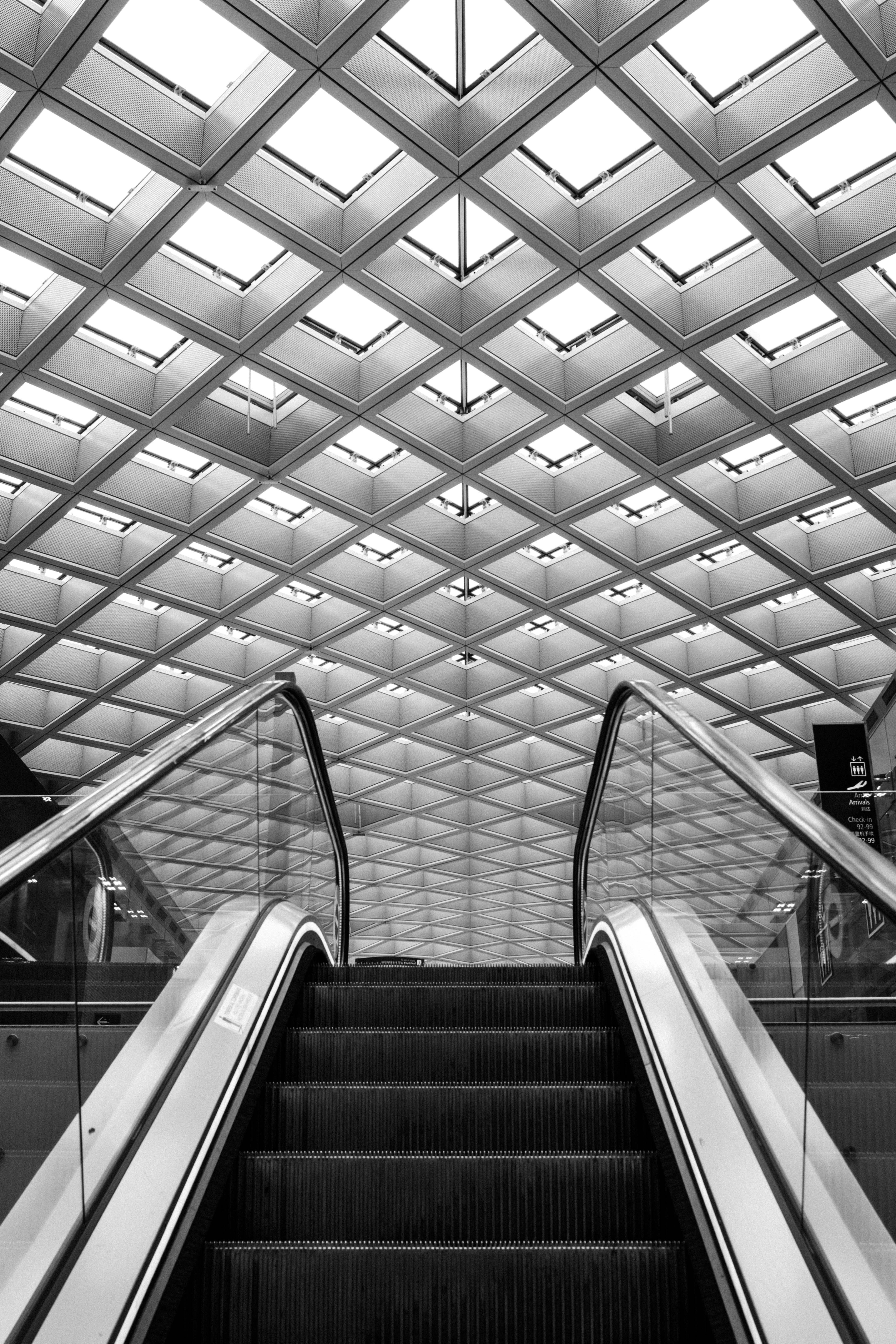 Escalator Under a Modern Ceiling in Black and White · Free Stock Photo
