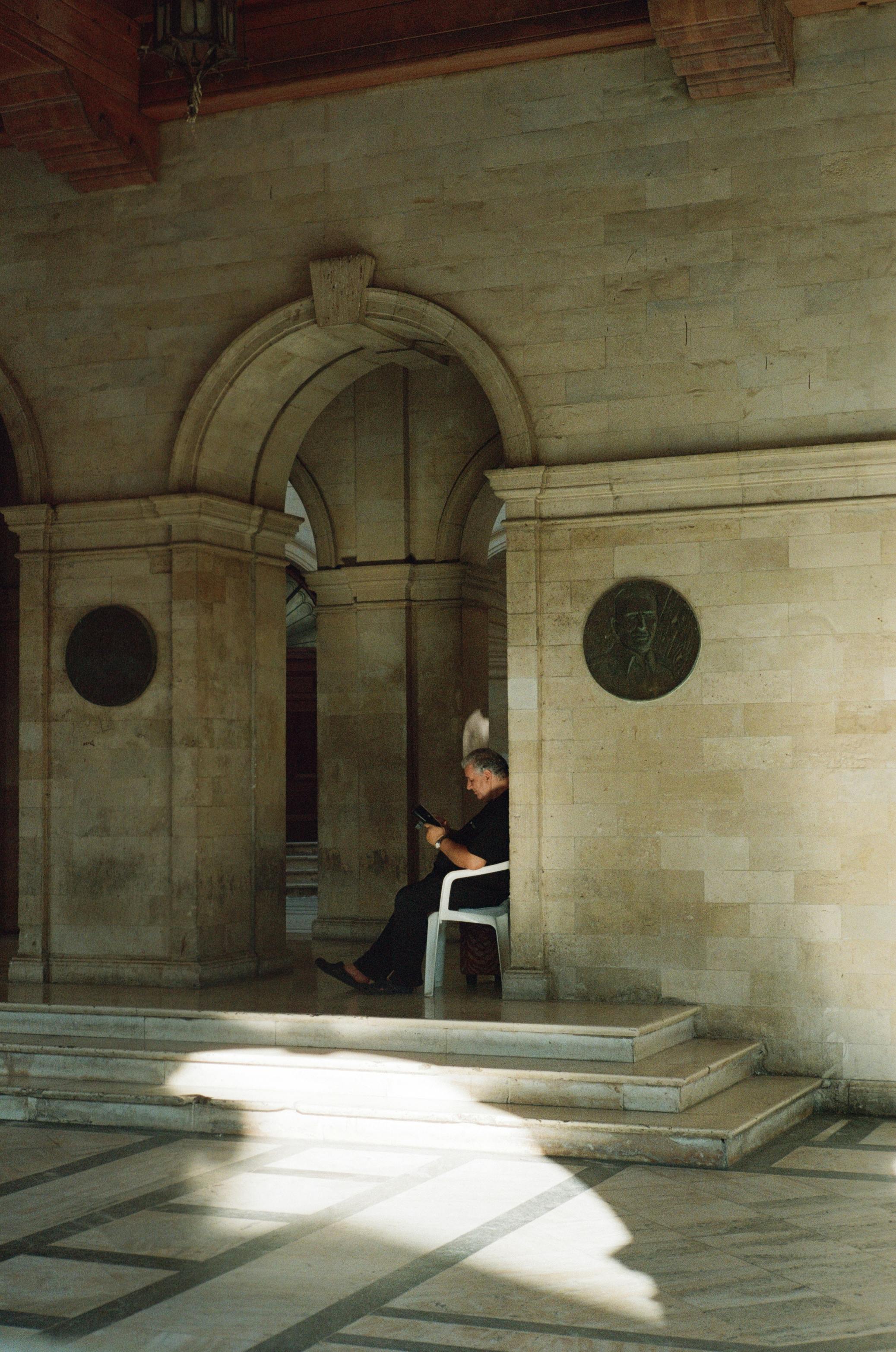 Old Architecture with Seated Man in Shadow · Free Stock Photo