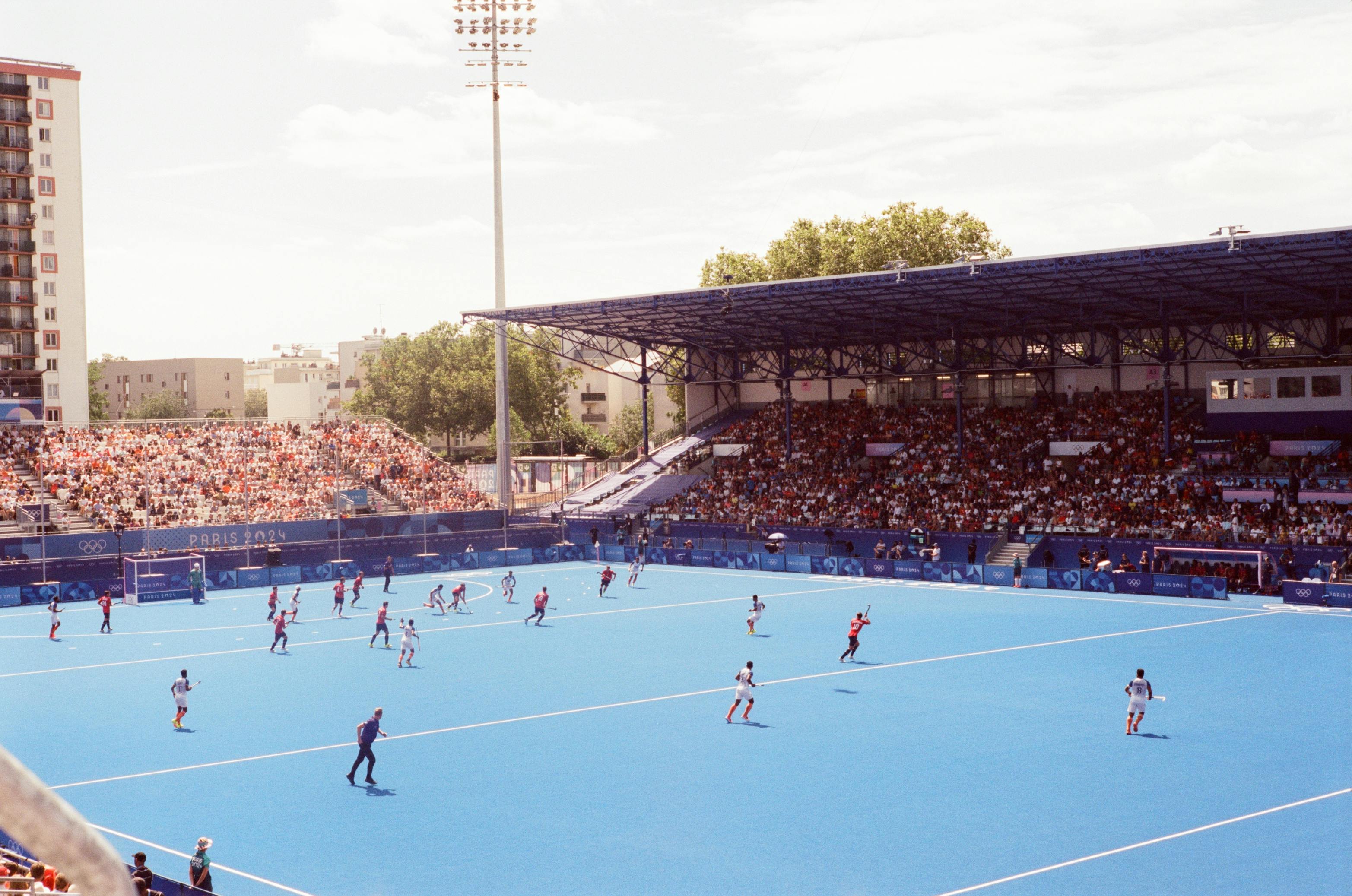 Exciting Field Hockey Match at Paris 2024 Stadium · Free Stock Photo