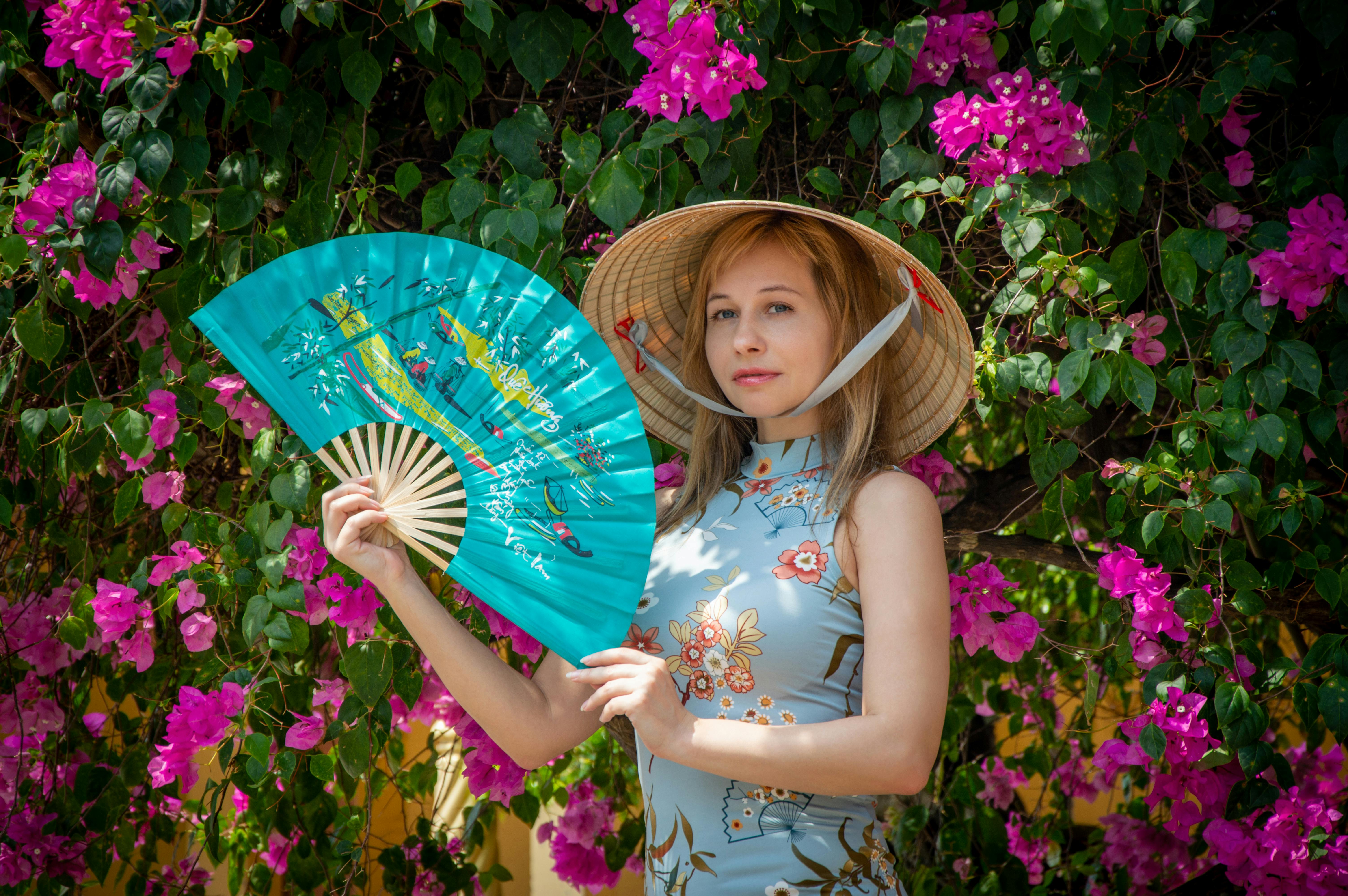 Woman in Asian Attire with Fan and Bougainvillea · Free Stock Photo