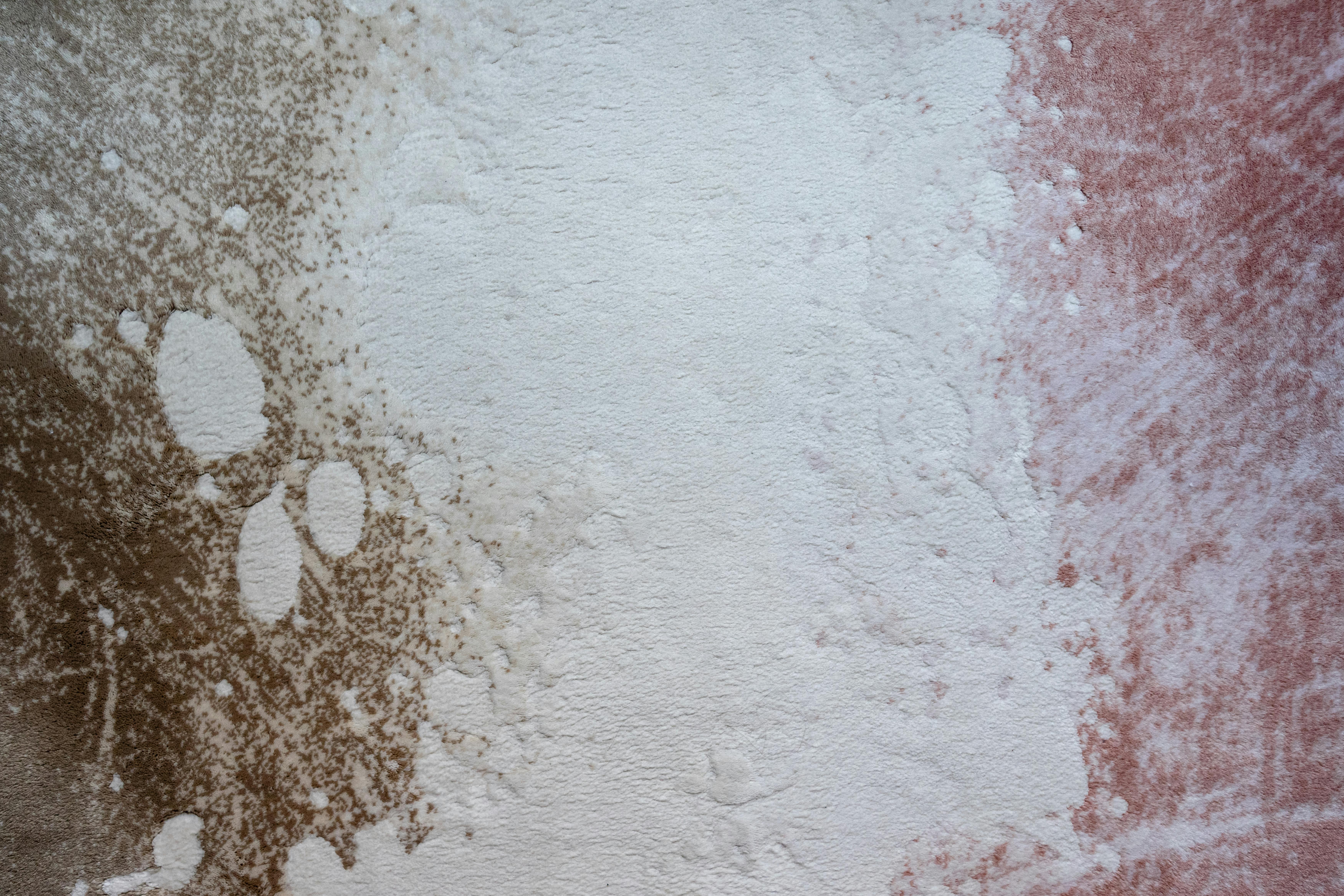 A white and red paint splattered wall with a hole in it · Free Stock Photo
