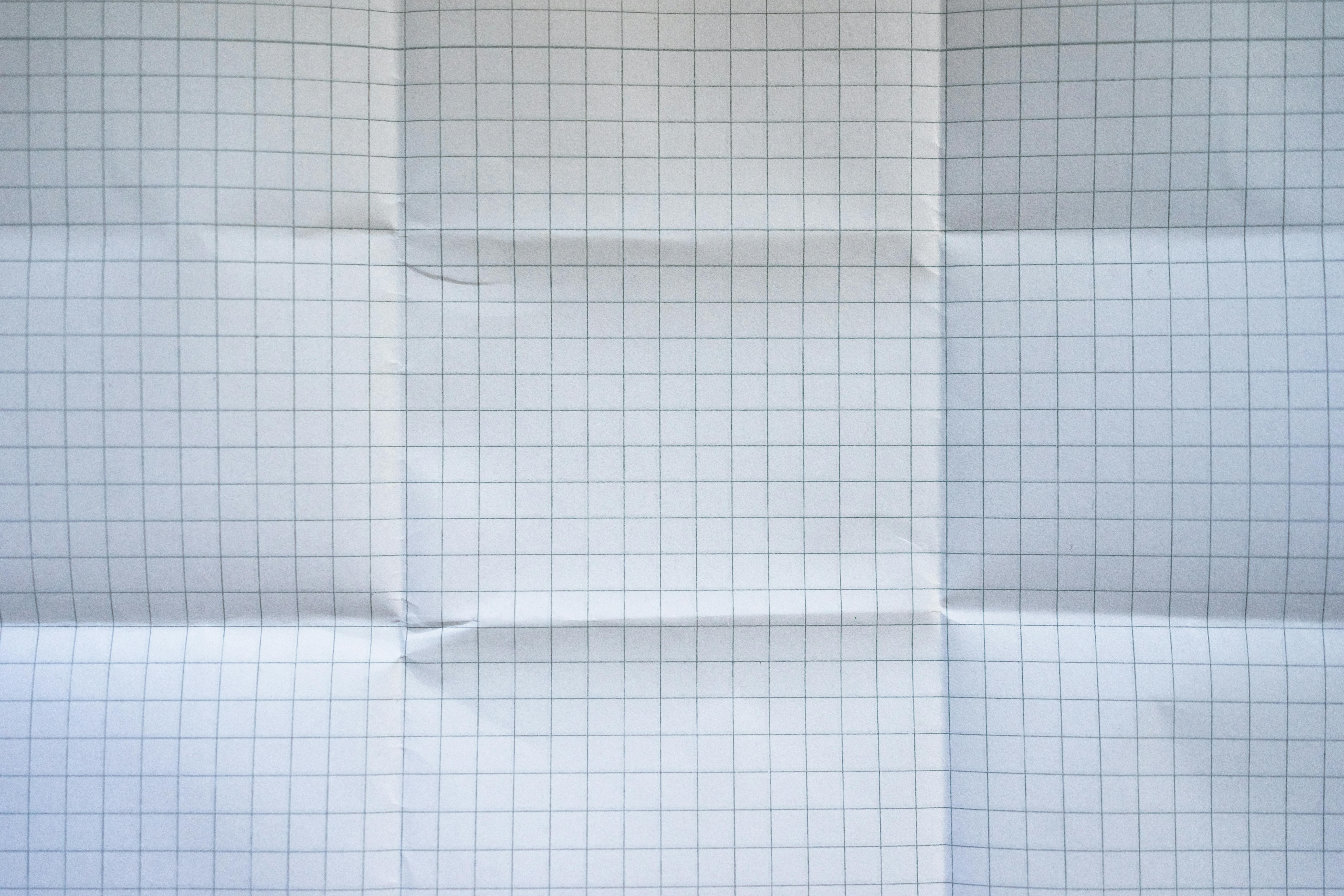 A piece of paper with a grid pattern on it · Free Stock Photo